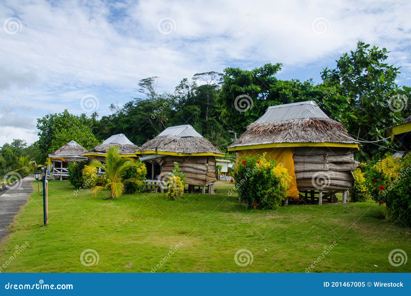 Small Huts Surrounded by Greenery Under a Cloudy Sky in Manase, Samoa ...