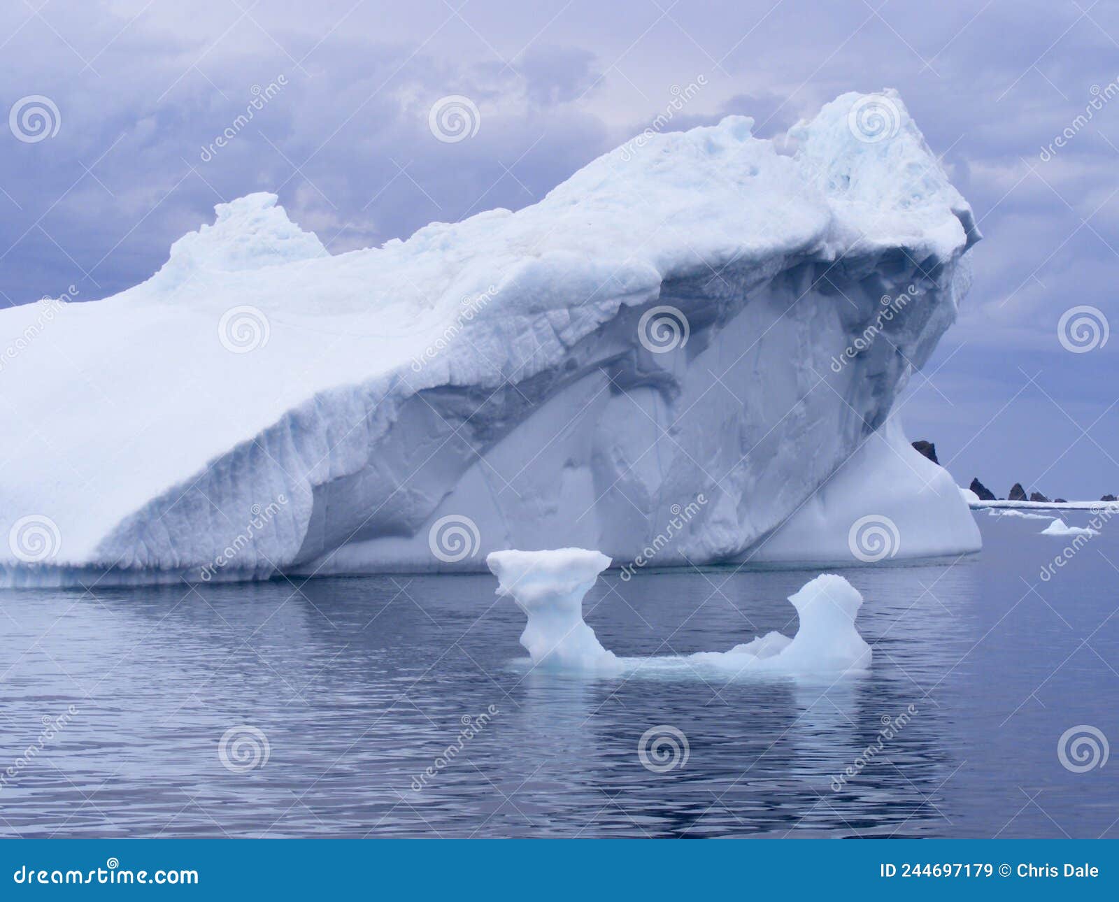 Small Ice Chunk Floating in Front of Large Iceberg in Twillingate ...