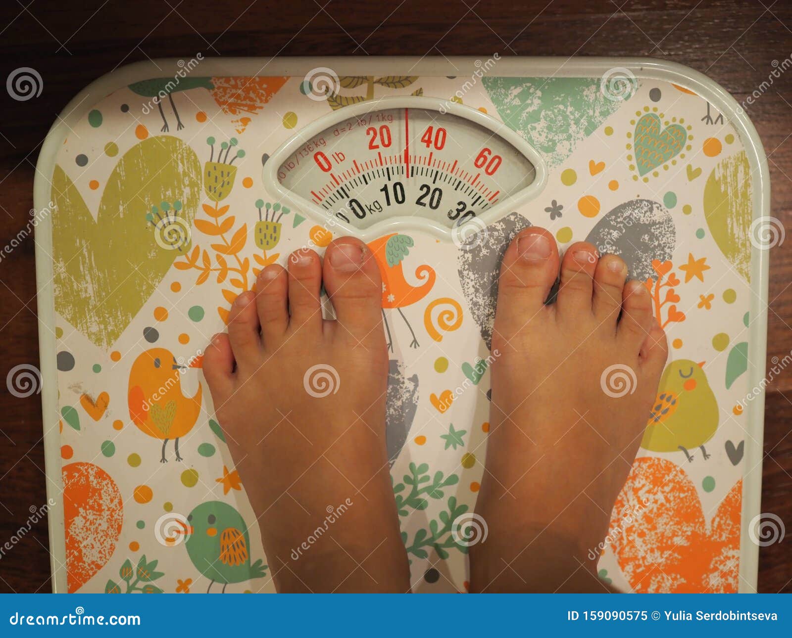 Small Kid`s Legs Standing on the Scales Closeup. Top View Stock Image ...