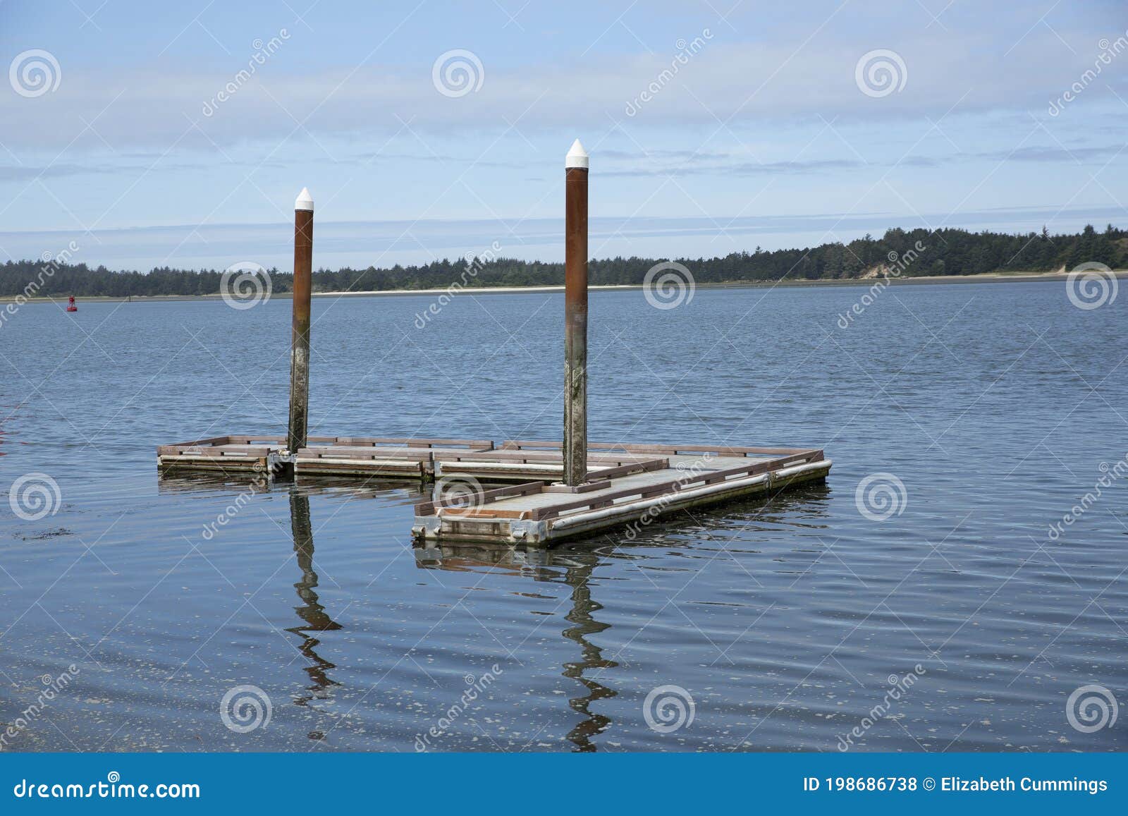 Small L Shaped Floating Boat Dock with Two Columns Topped by White Caps ...