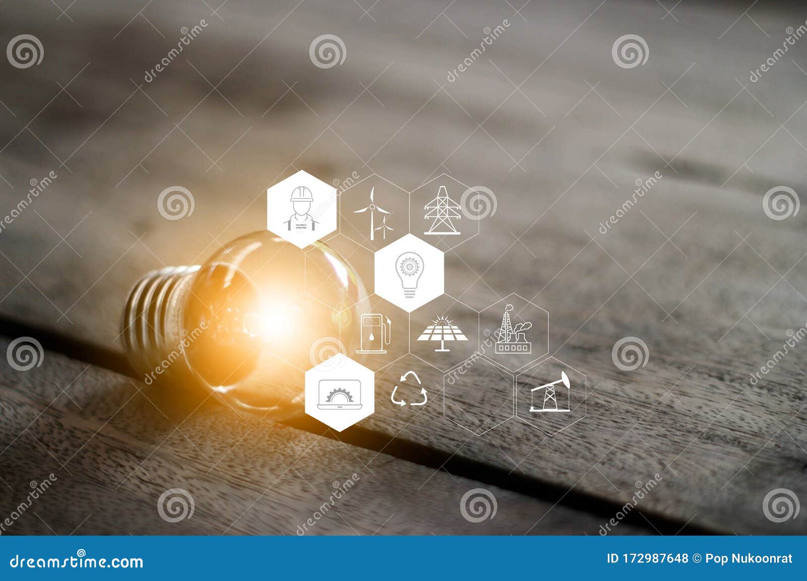 Small Light Bulb Glowing on Table with Icons Energy Sources for ...