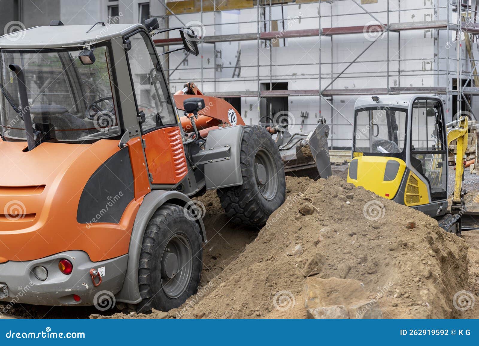 Small Loader and Excavator Digger Machine Moving Heap of Earth and ...