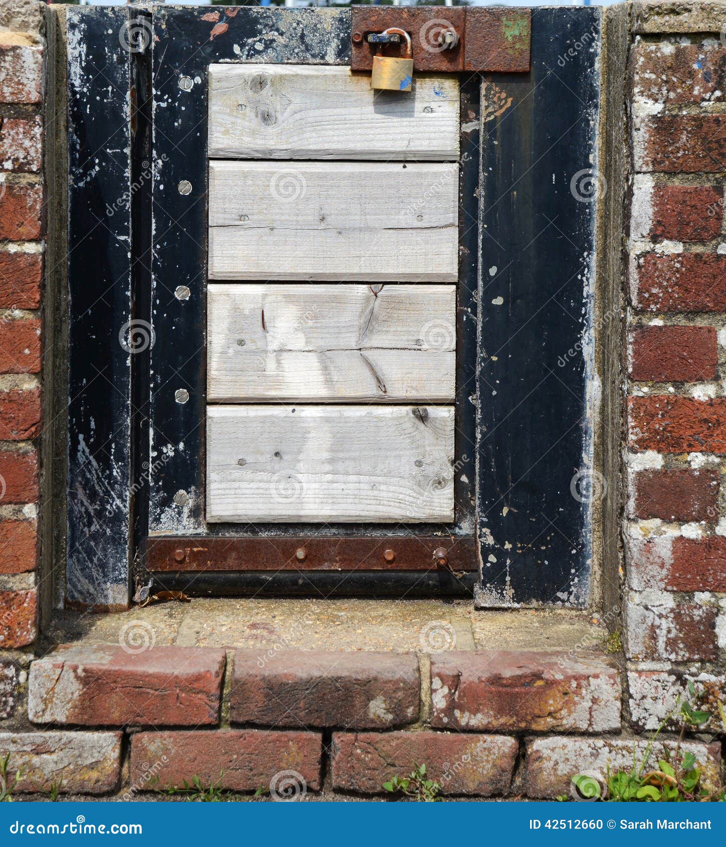 Small Locked Gate in a Brick Wall Stock Photo - Image of metal, rough ...