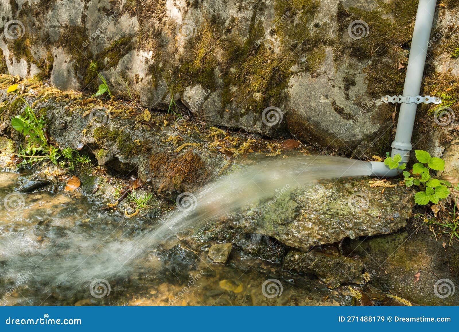 A Small Waterfall Flowing from the Mountains through a Pipe Stock Image ...