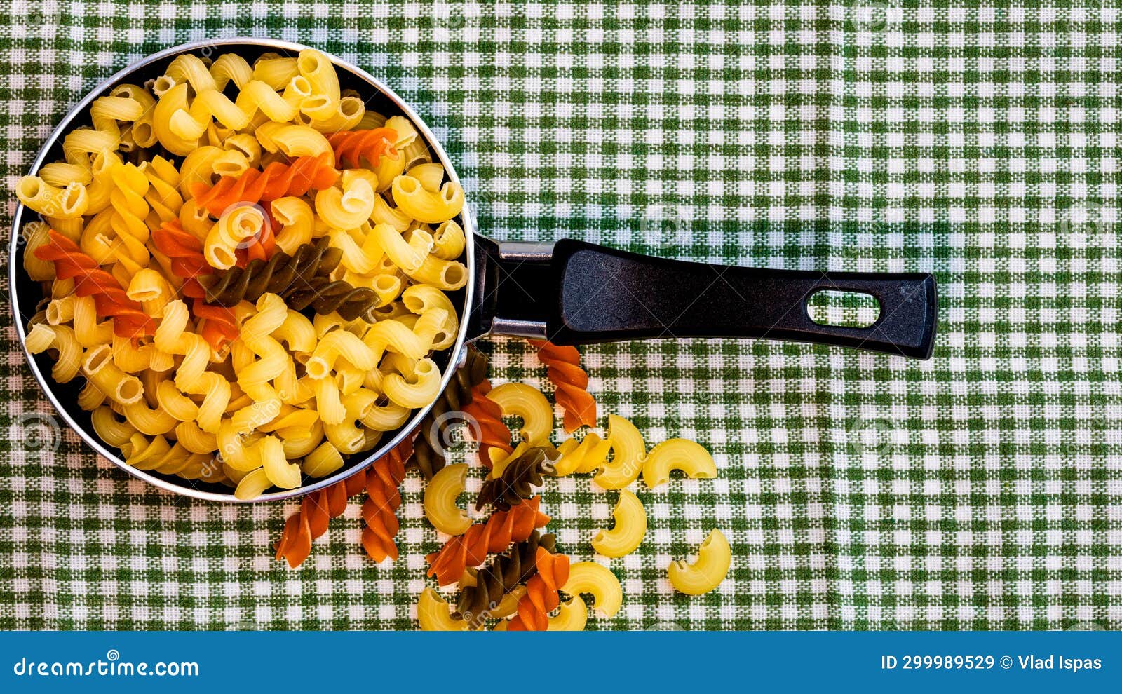 Small Mini Frying Pan with Tricolor Raw Fusilli Pasta in a Rustic ...