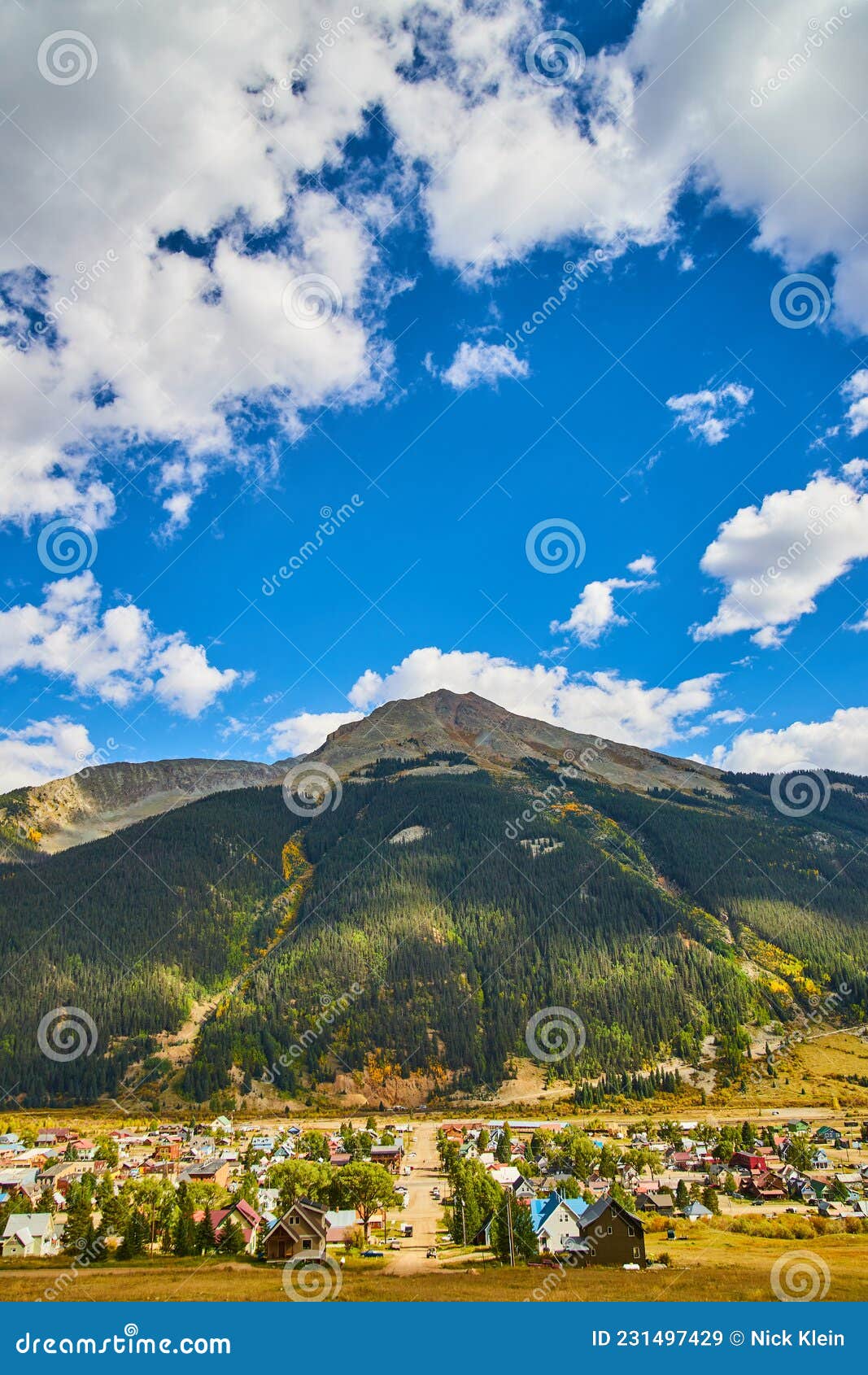 Small Mining Town in the Country with Tall Mountain Range and Blue Sky ...