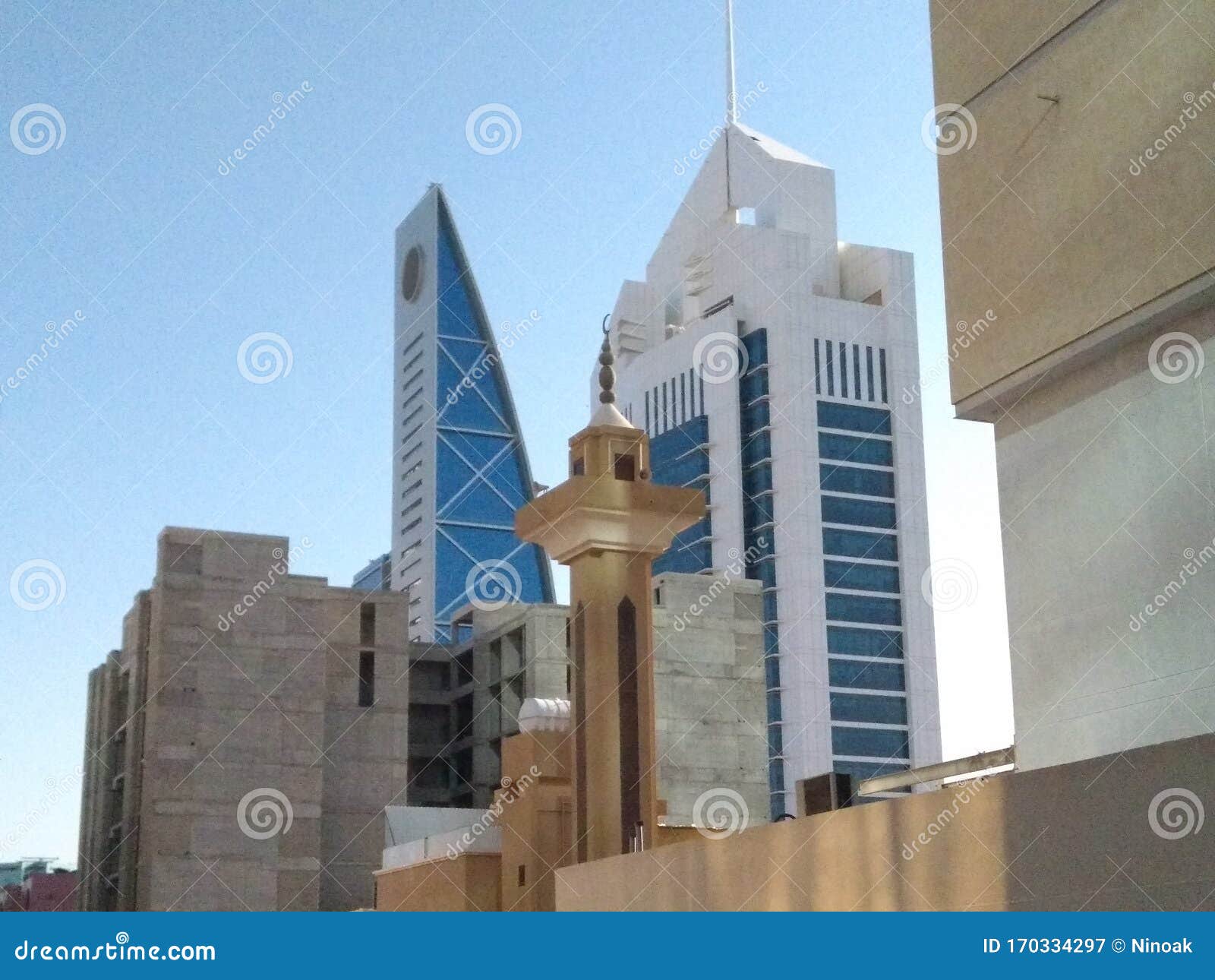 Small Mosque with Square Minaret Surrounded by the Modern Architecture ...