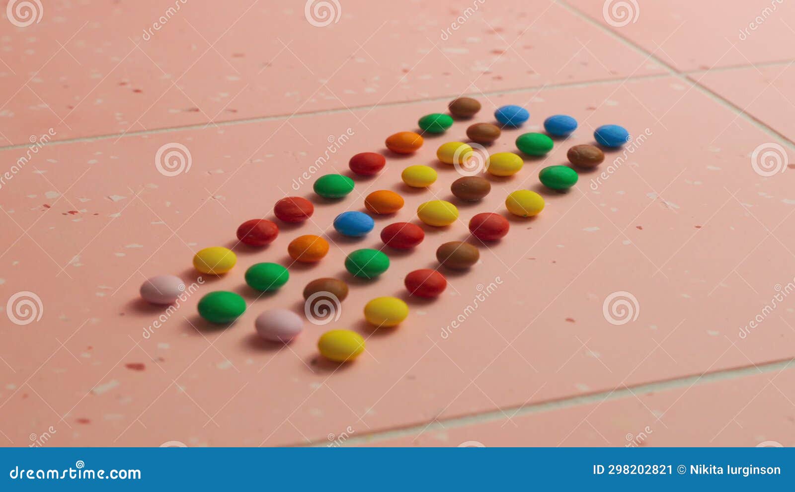 Small Multi-colored Round Candies on a Pink Background Stock Video ...