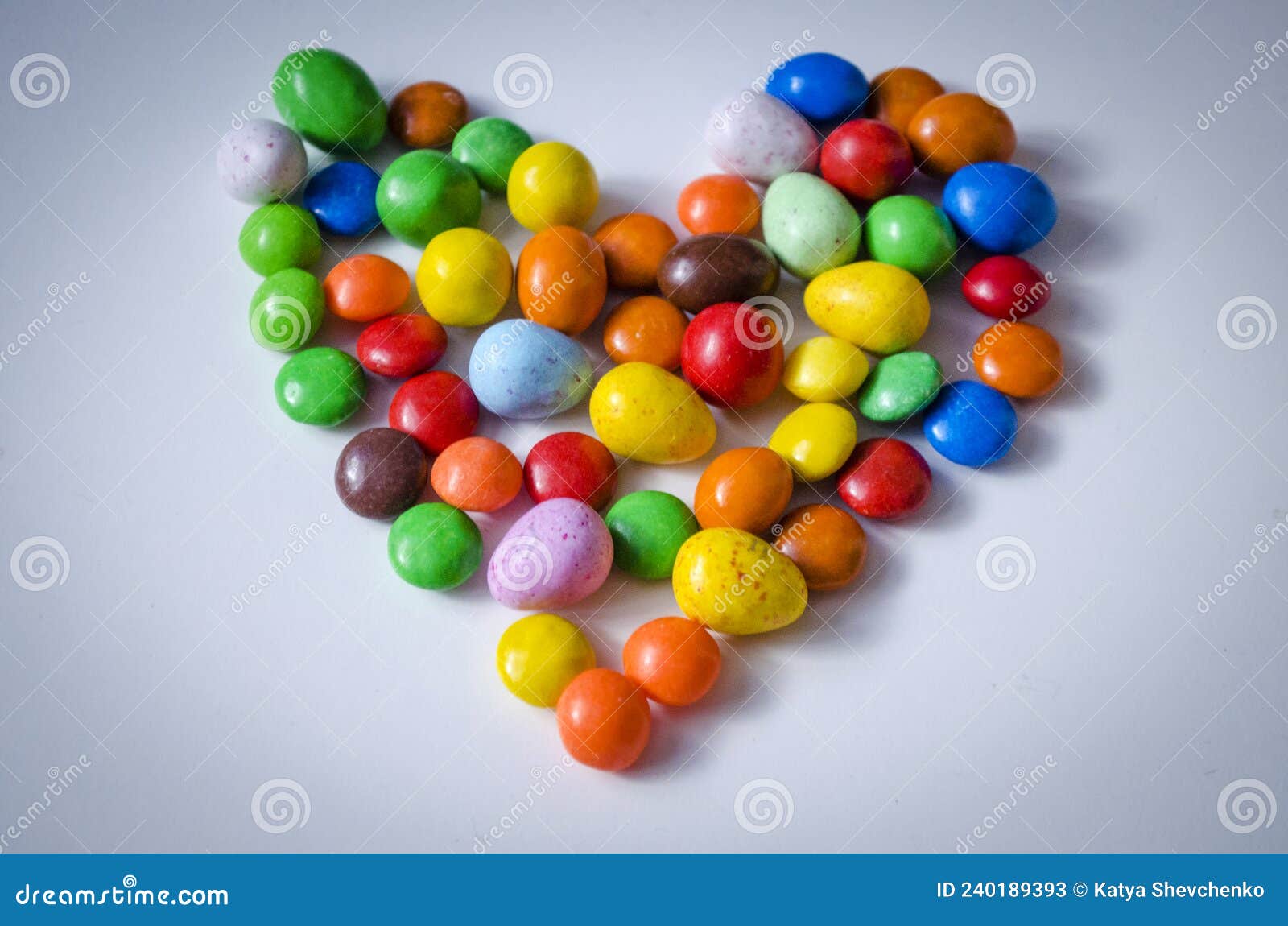 Small Multi-colored Sweets in the Form of a Heart on a White Background ...