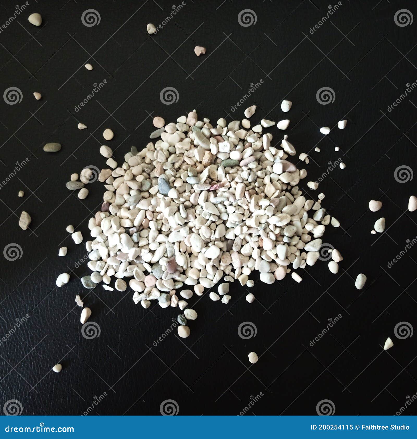Small Multi Colored White Stone Gravel Pathway in Solid Black Fabric ...