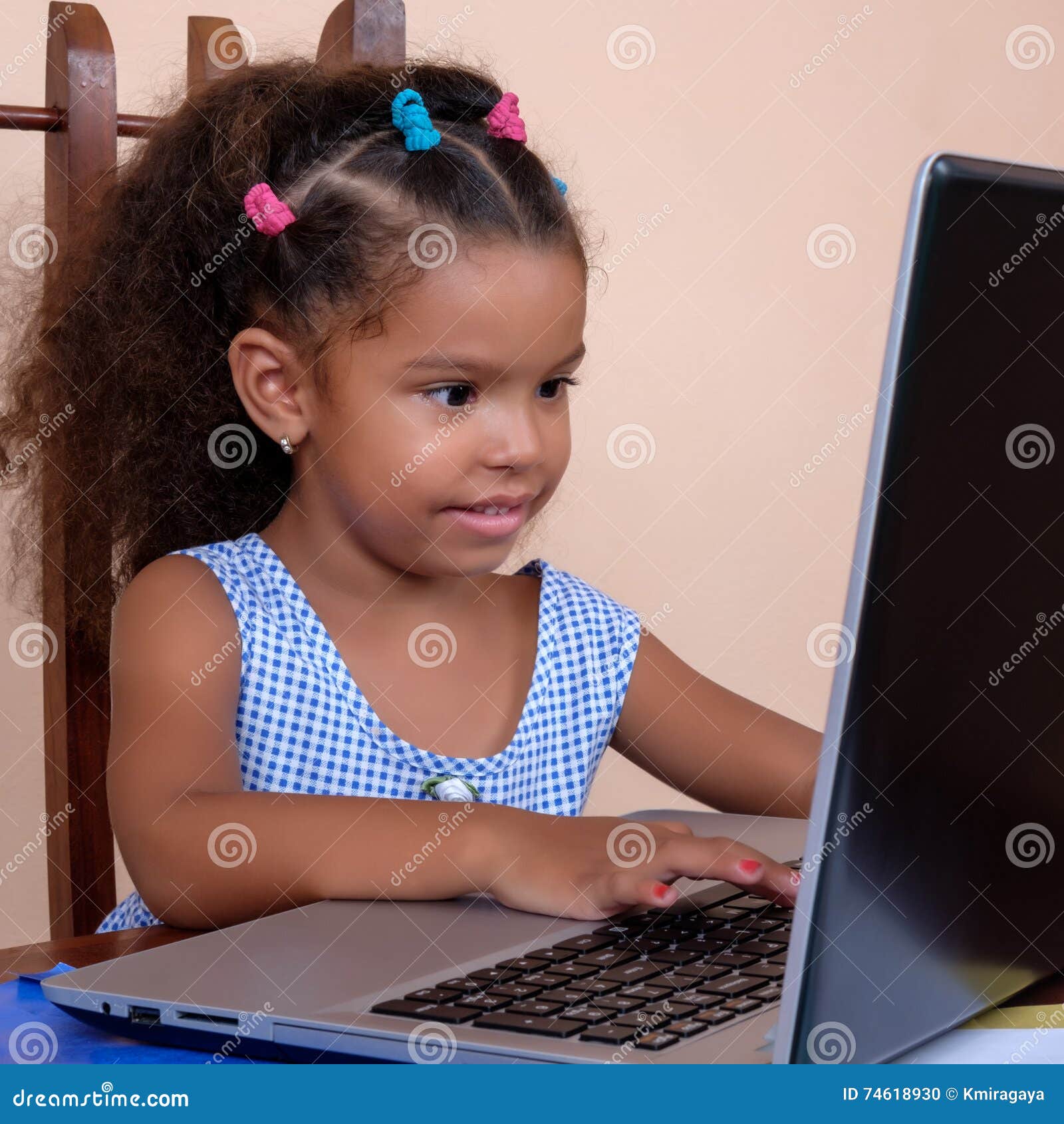 Small Multiracial Girl Working on a Laptop Computer Stock Photo - Image ...