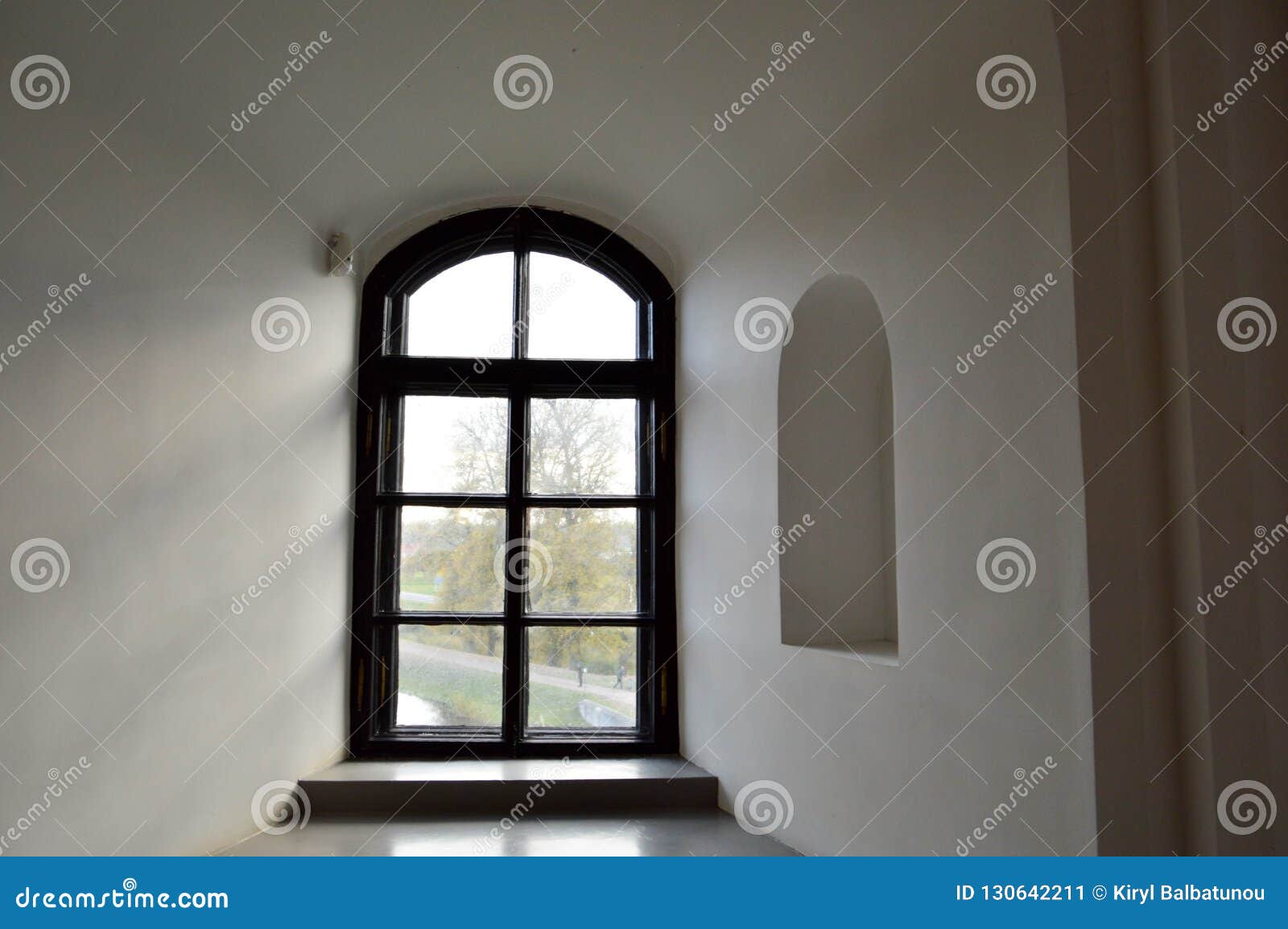A Small Narrow Black Window with a Frame on an Old Ancient Stone White ...