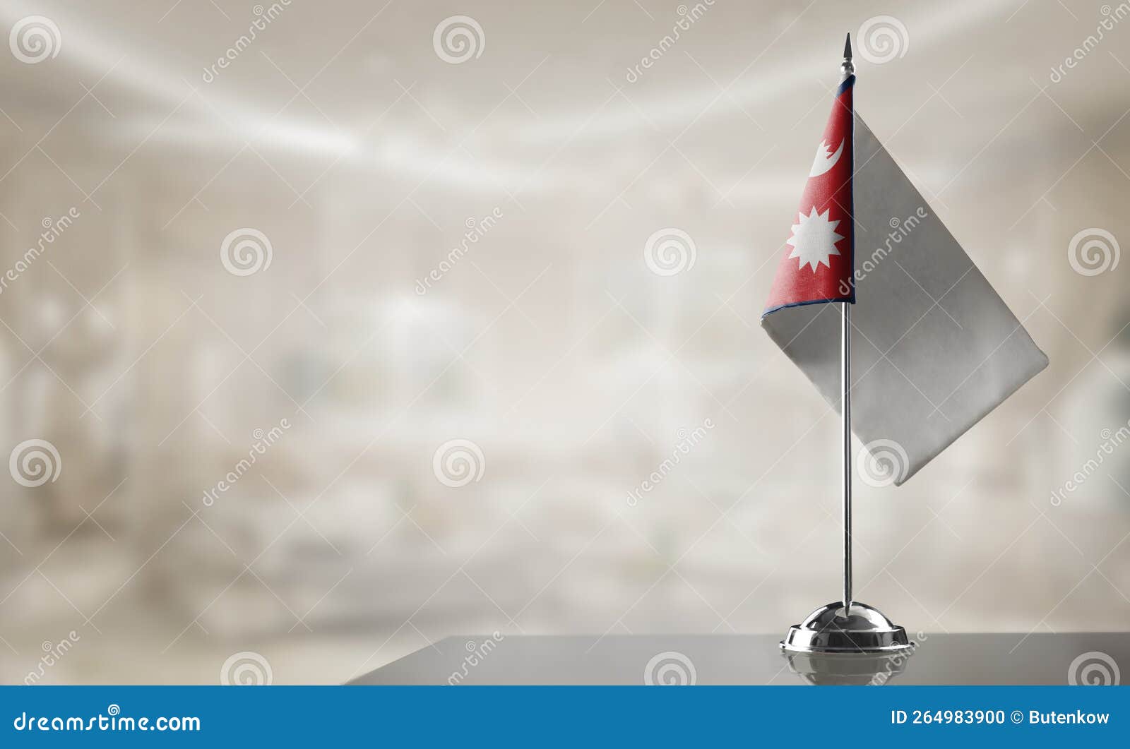 A Small Nepal Flag on an Abstract Blurry Background Stock Photo - Image ...
