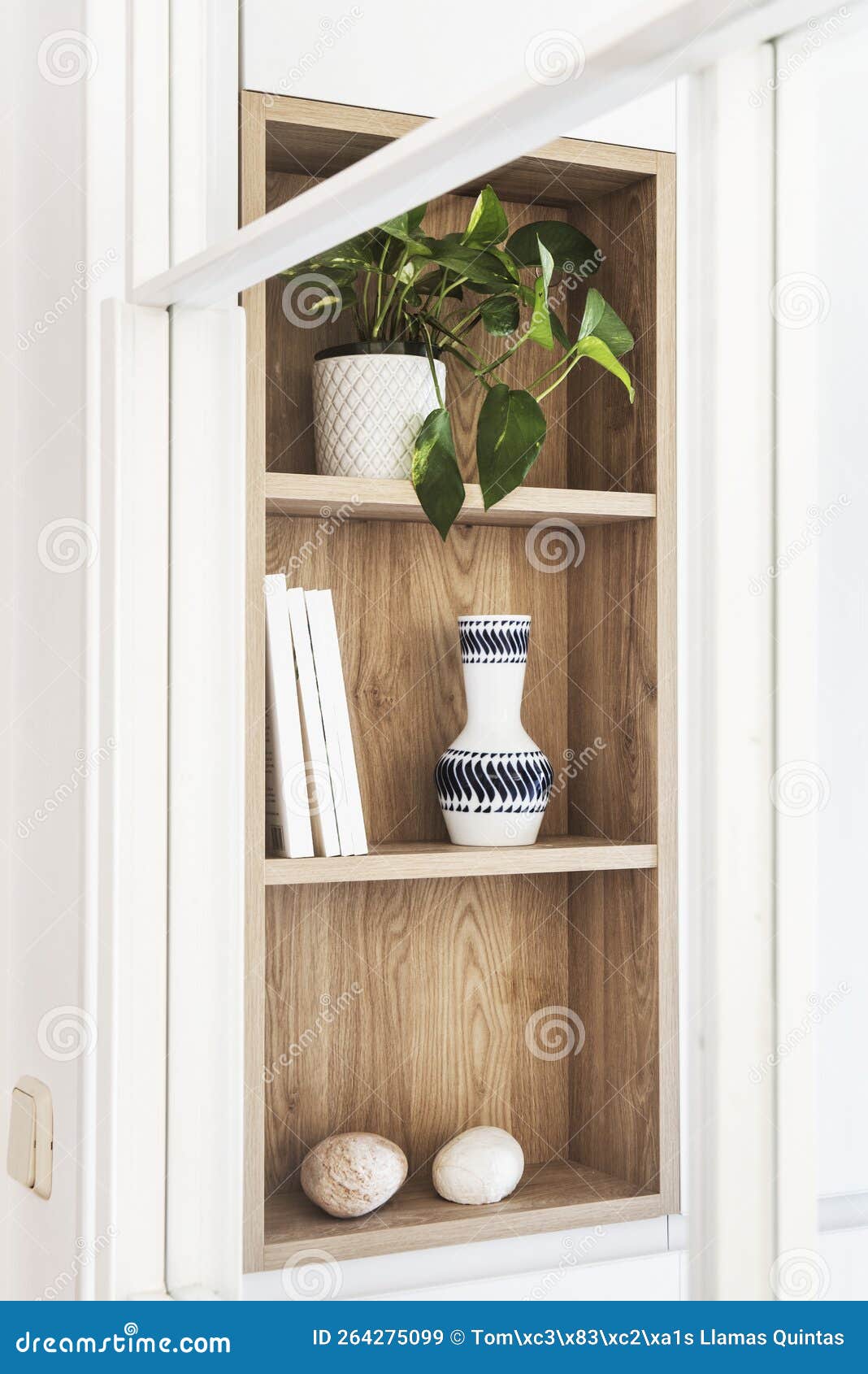 A Small Oak Shelf Integrated into a Niche in a Wall with Decorative ...
