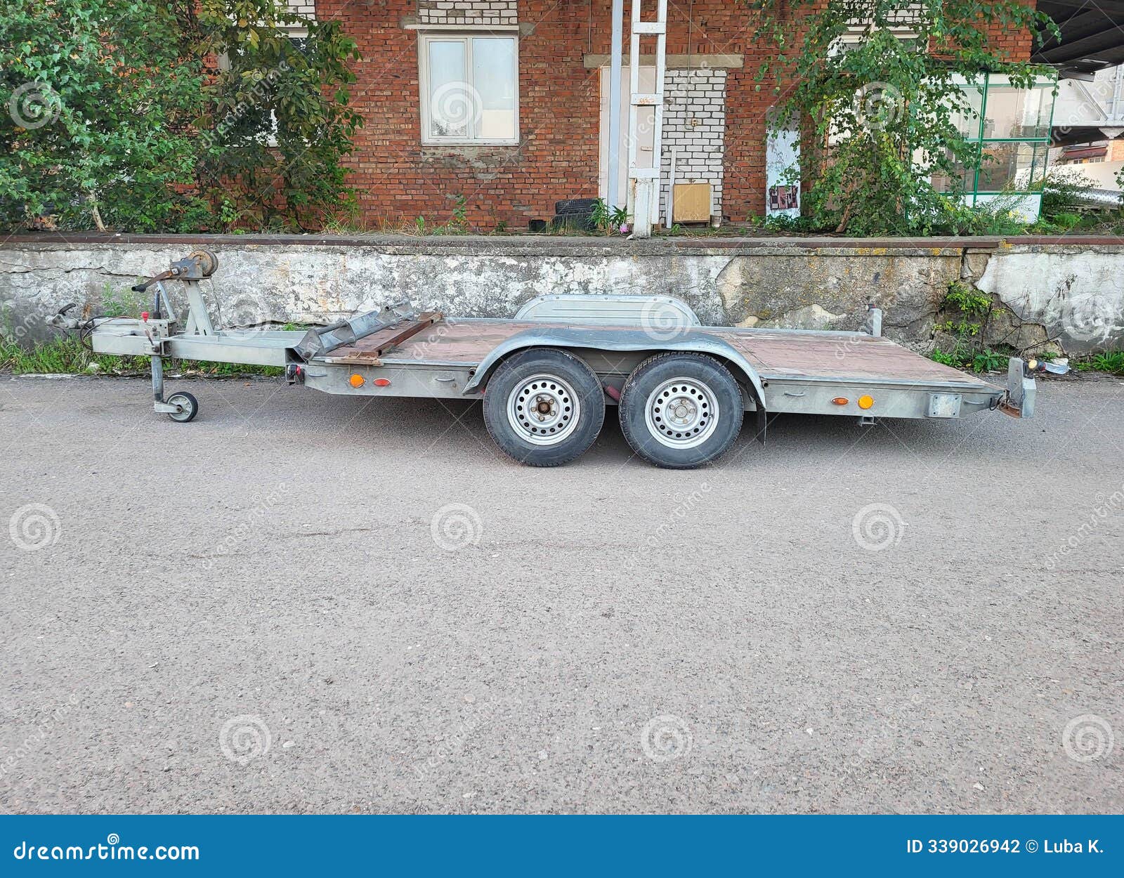 A Small Open Empty Cargo Trailer is Parked in the Yard. Stock Photo ...