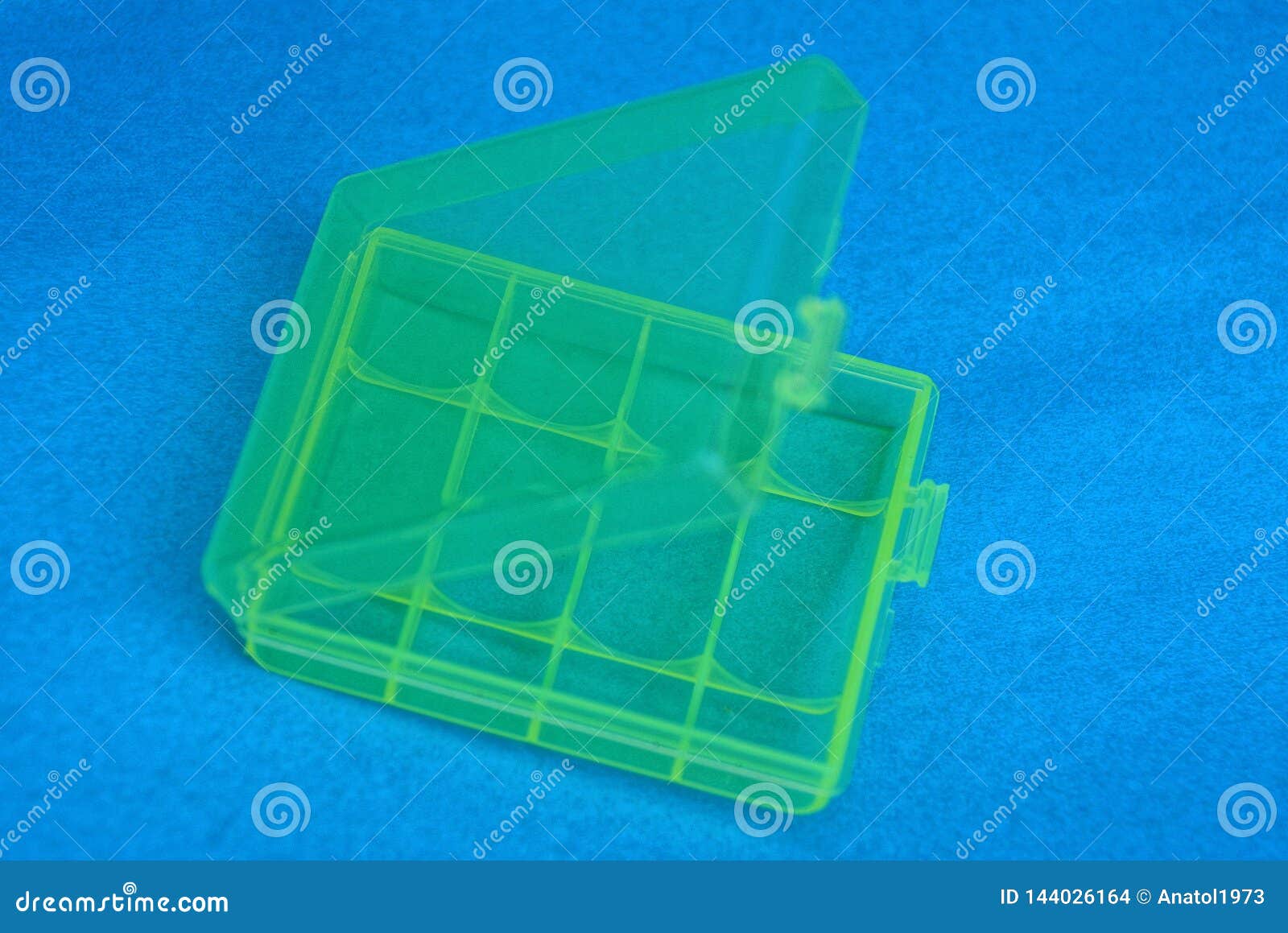 A Small Open Green Plastic Box is on a Blue Table Stock Photo - Image ...