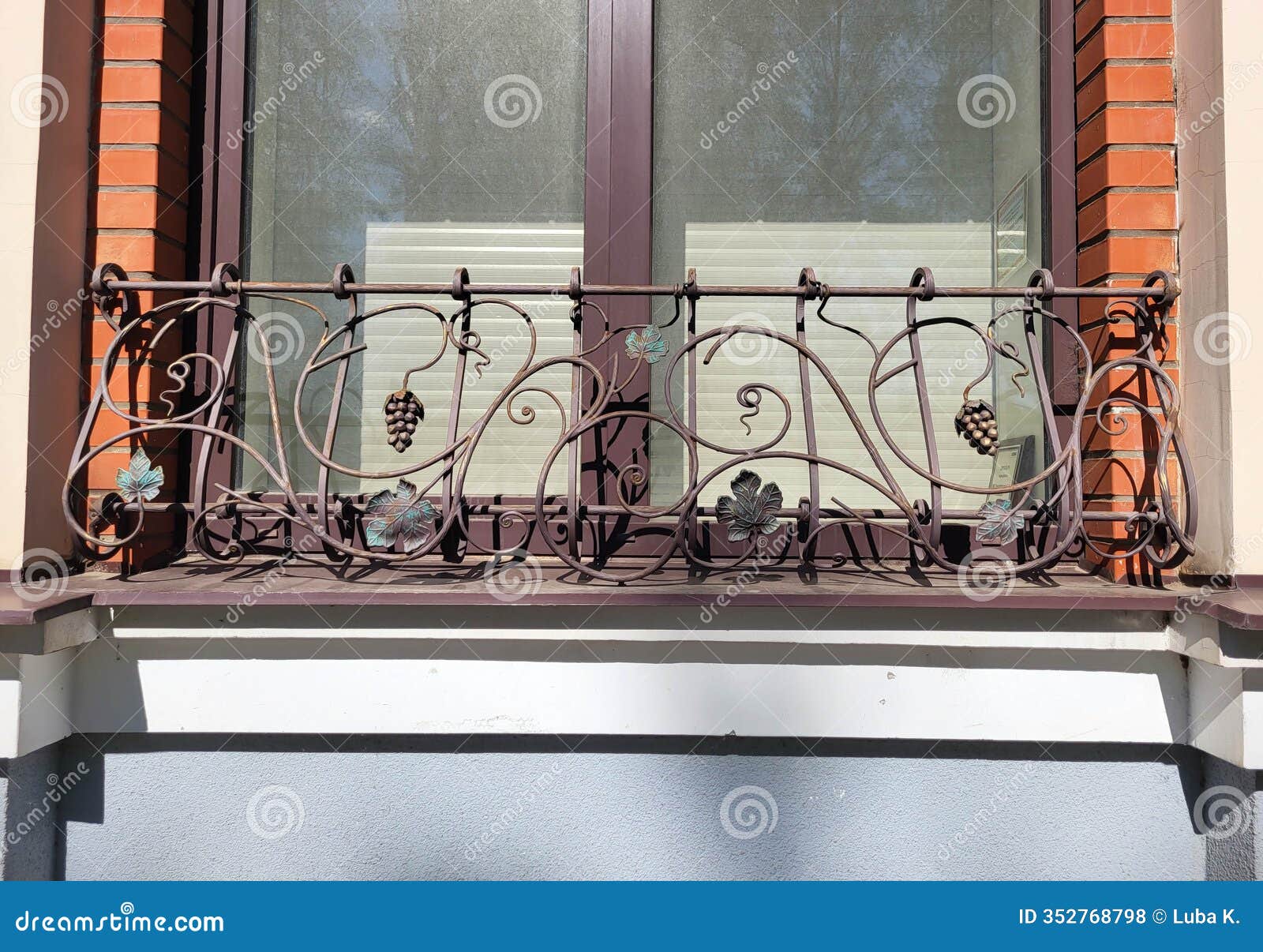 A Small Openwork Wrought Iron Grating on the Window of a Brick Red ...