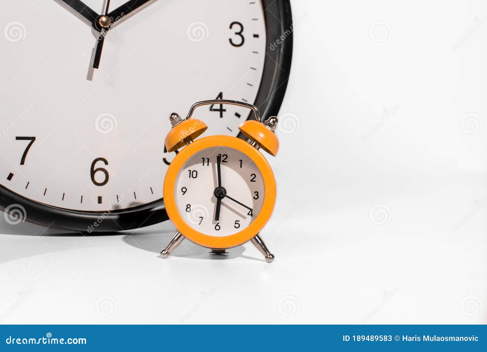 Small Orange Analog Clock with Big Clock Concept Time Passing Faster ...