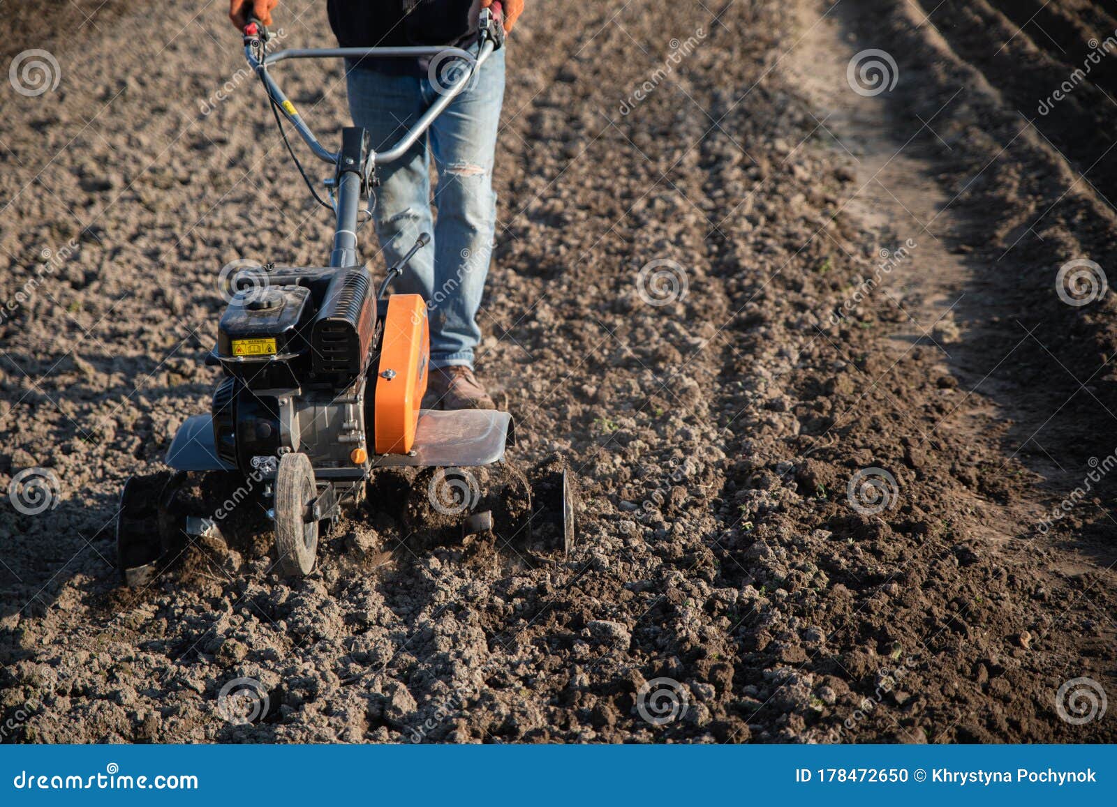 Small Plowing Machine in Hands of a Farmer Making Arable in Black Soil ...