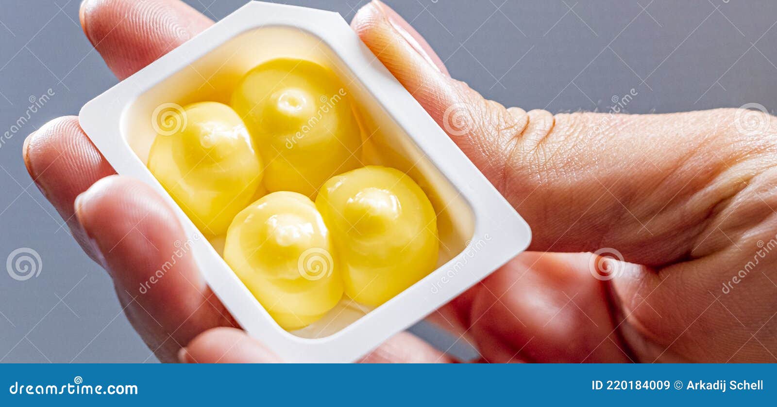 Small Packet of Butter in Hand on the Plane Stock Image - Image of ...