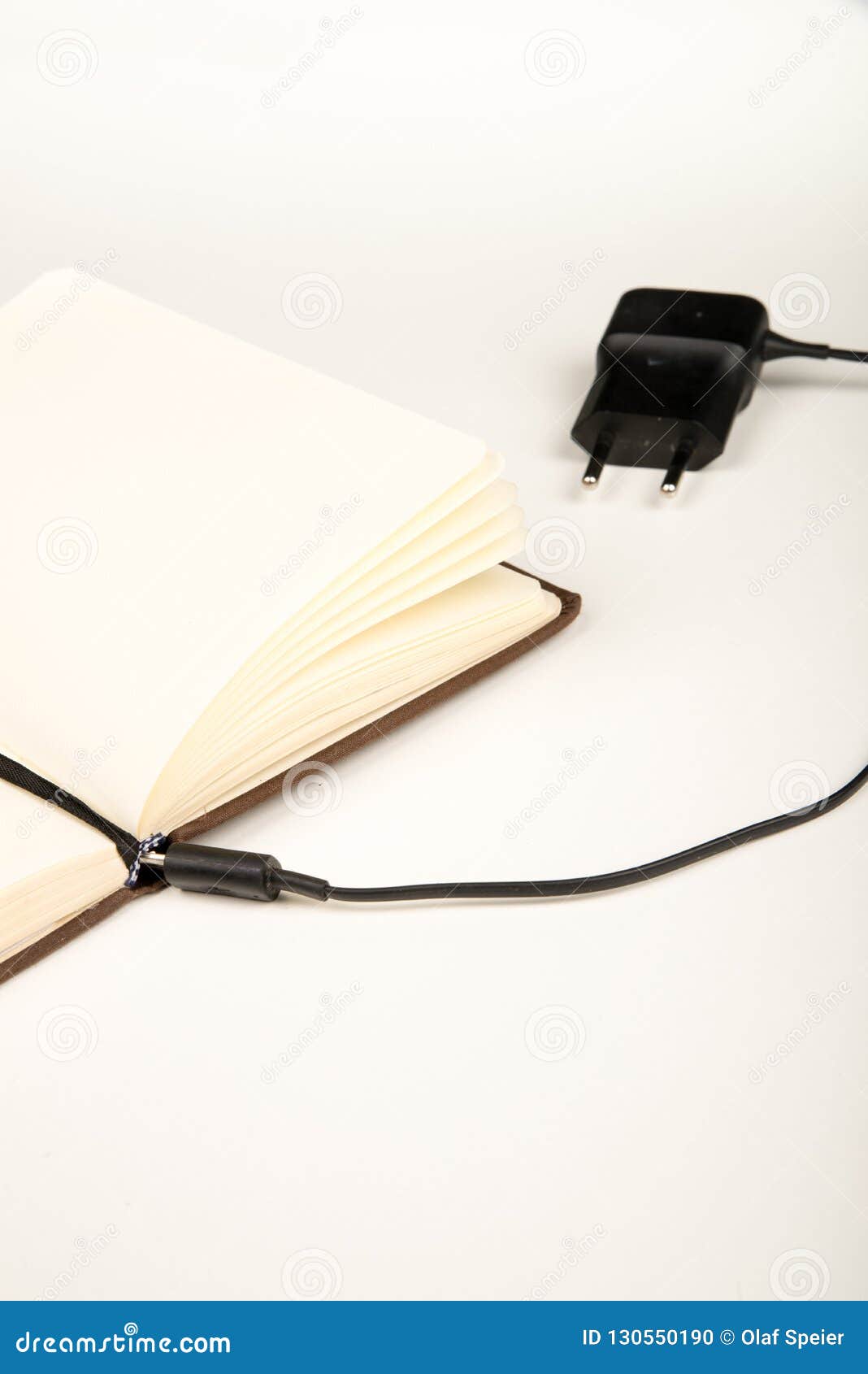Small Paper Notebook and Battery Charger Stock Photo - Image of ...