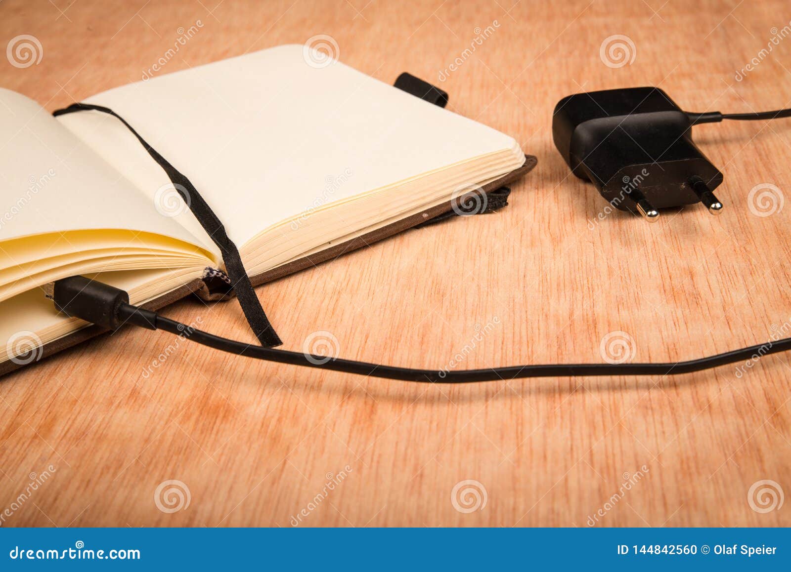 Small Paper Notebook and Battery Charger Stock Photo - Image of analog ...
