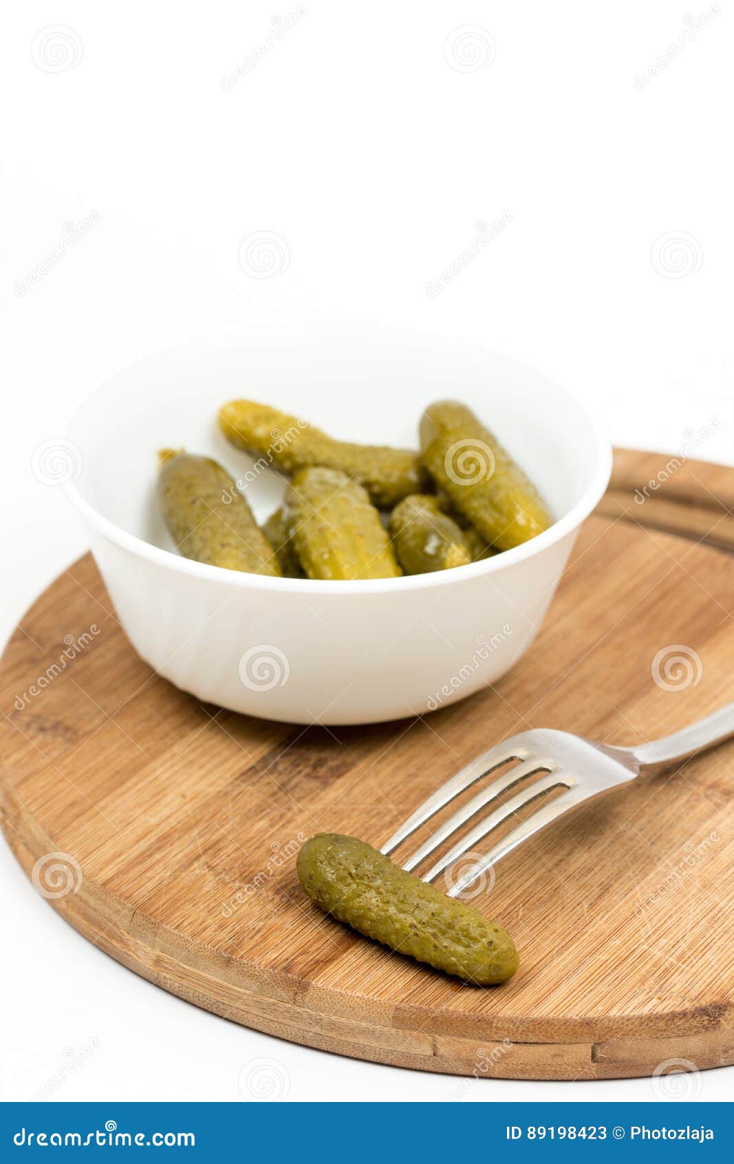 Small Pickles in the White Bowl and Pickle on the Fork Stock Image ...