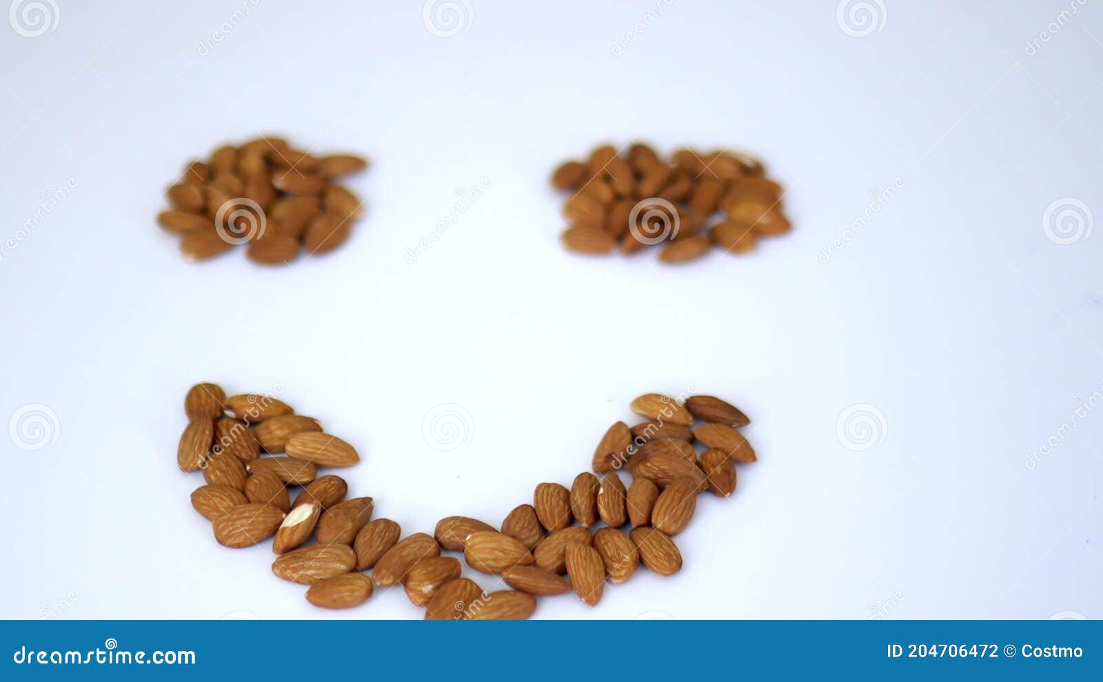 Small Pile of Almonds in a Smiley Face Shape on a White Table Stock ...