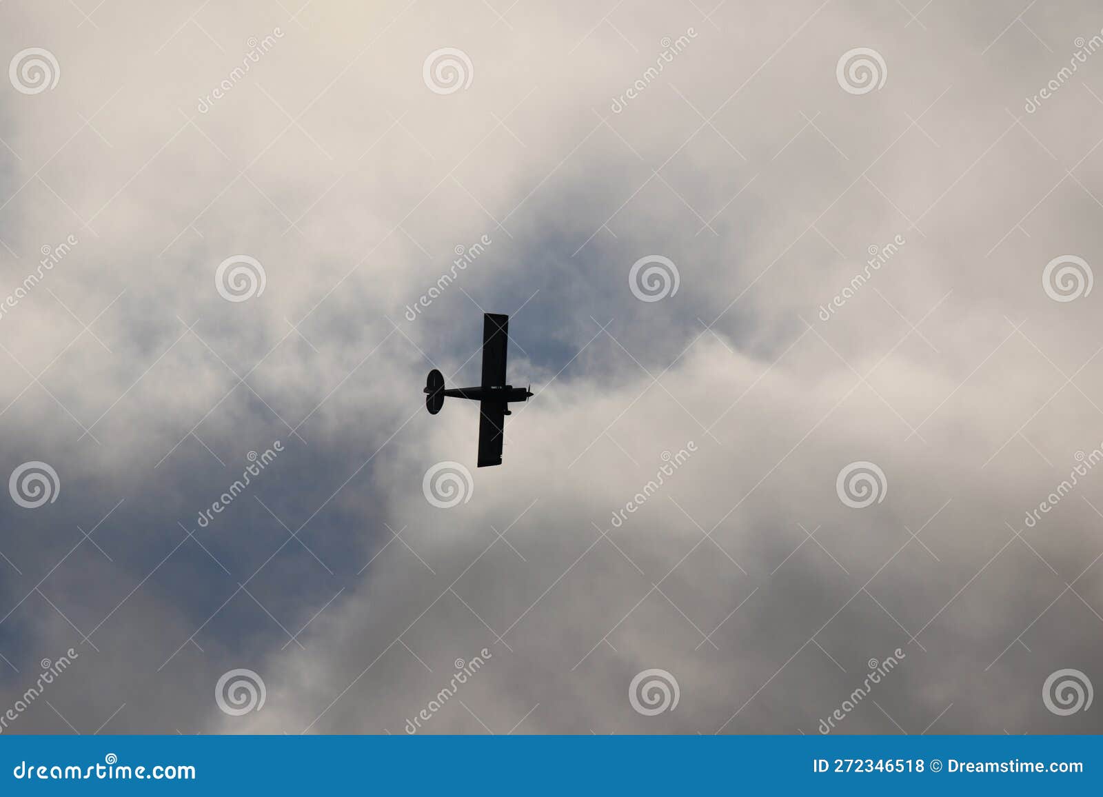 Small Plane Flying in the Sky Against Dark Clouds Stock Photo - Image ...