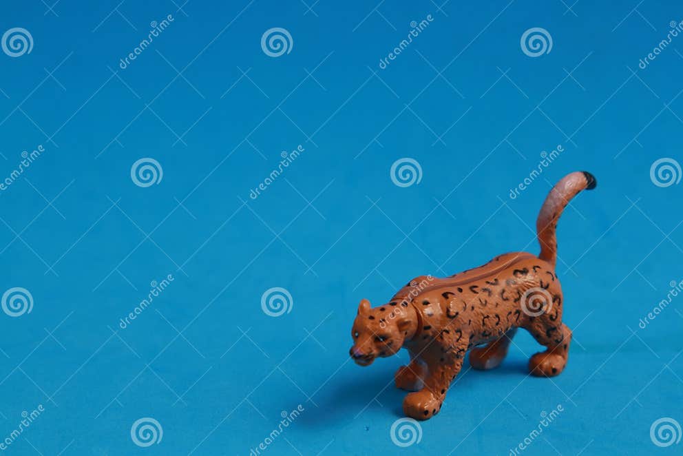 Small Plastic Leopard Toy Isolated on a Blue Background Stock Image ...