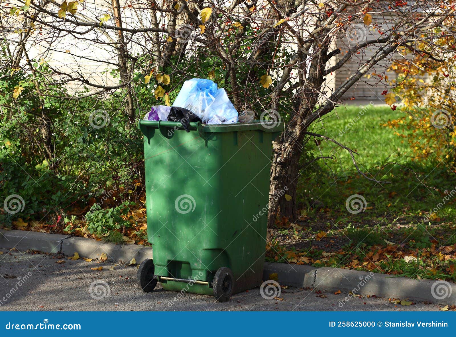 Small Plastic Mobile Garbage Container Filled with Garbage Stock Photo ...