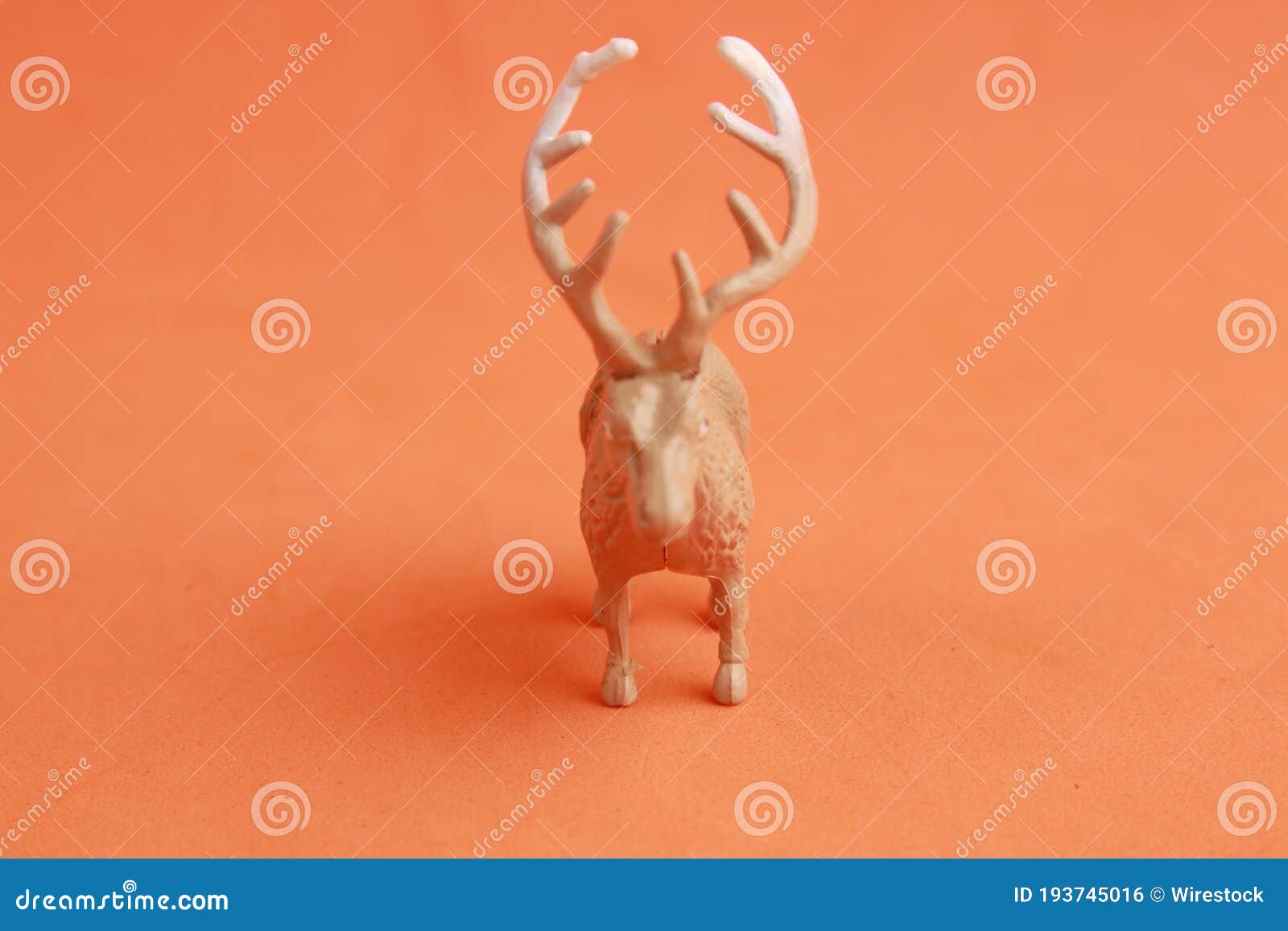 Small Plastic Reindeer Toy on an Orange Background Stock Photo - Image ...