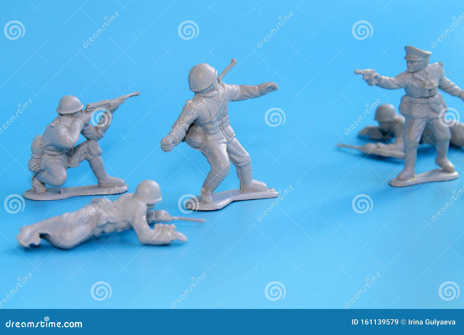 Small Plastic Soldiers Standing on a Blue Background Stock Image ...
