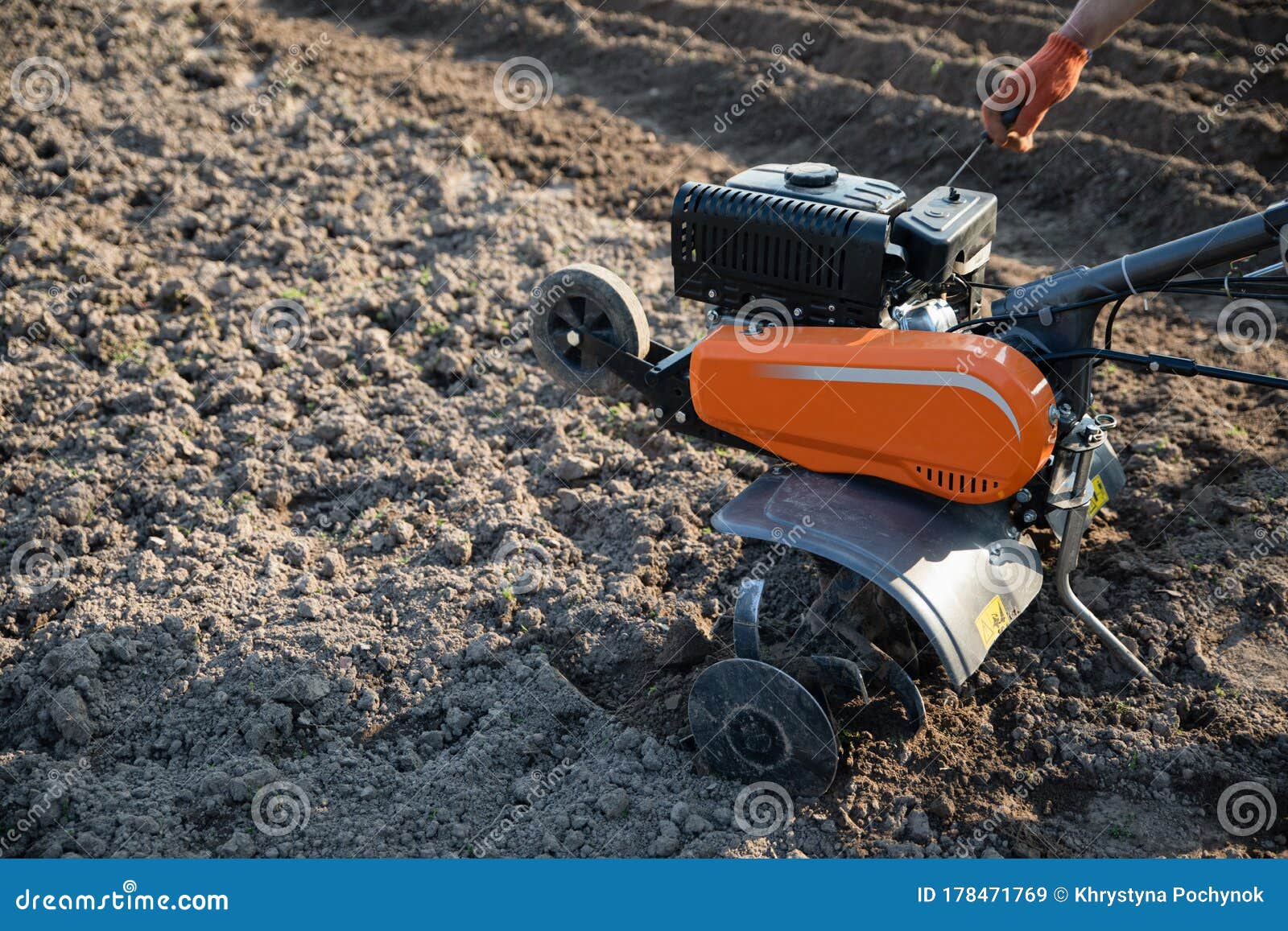 Small Plowing Machine in Hands of a Farmer Making Arable in Black Soil ...