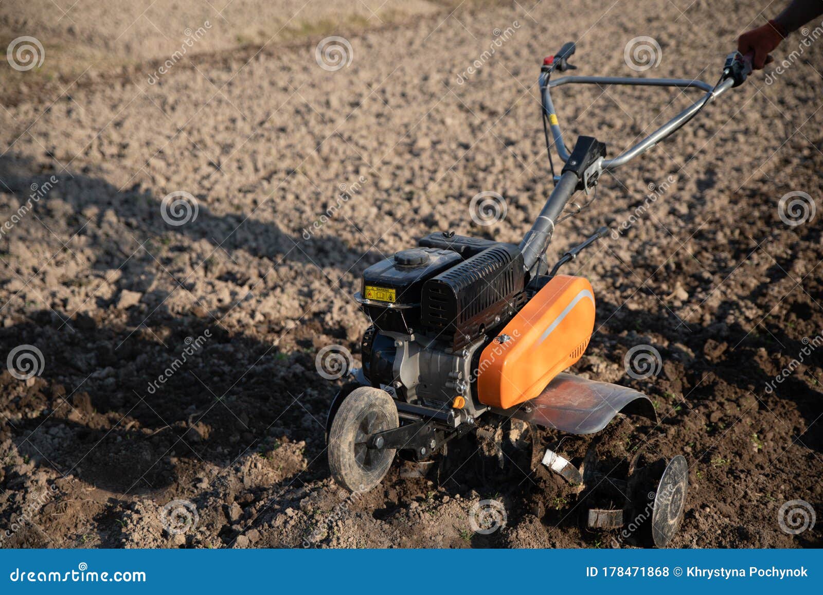 Small Plowing Machine in Hands of a Farmer Making Arable in Black Soil ...