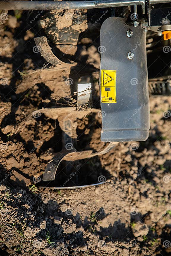 Small Plowing Machine in Hands of a Farmer Making Arable in Black Soil ...