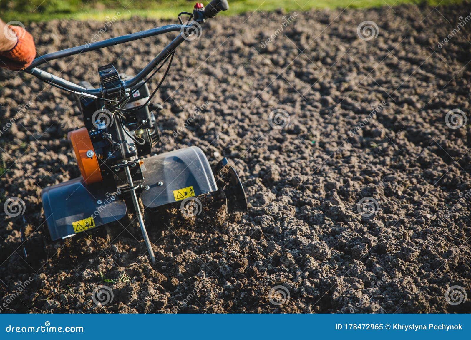 Small Plowing Machine in Hands of a Farmer Making Arable in Black Soil ...