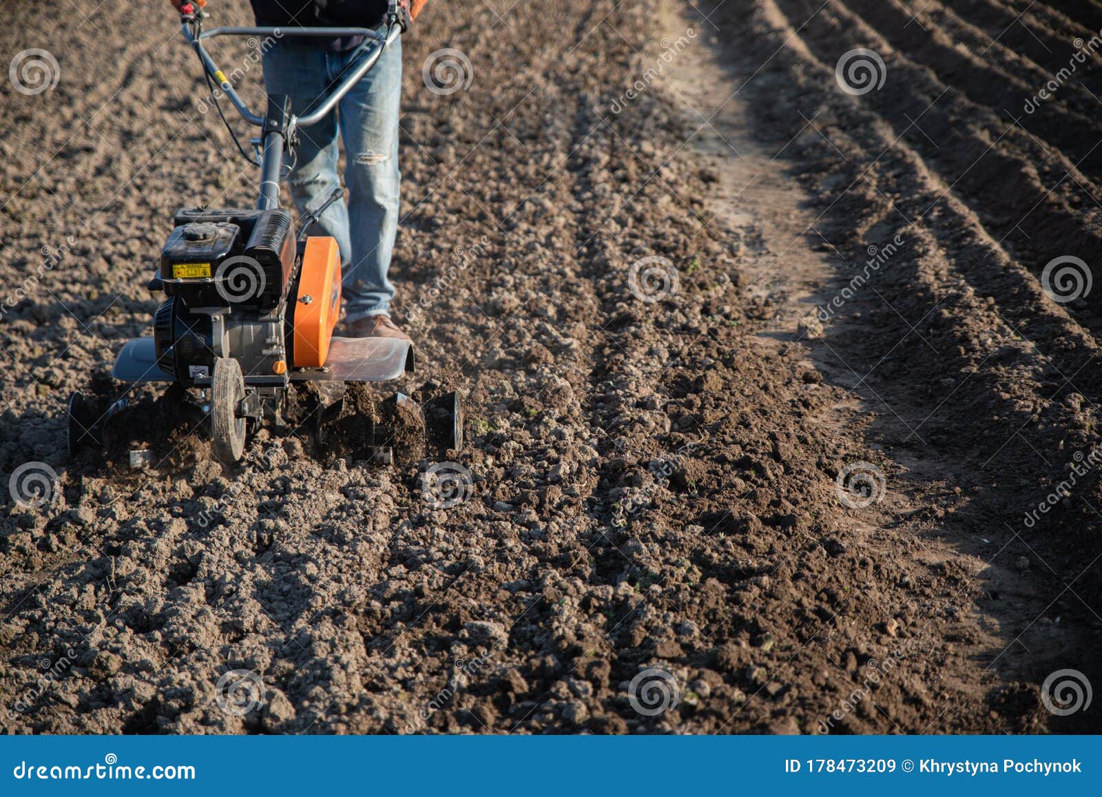 Small Plowing Machine in Hands of a Farmer Making Arable in Black Soil ...