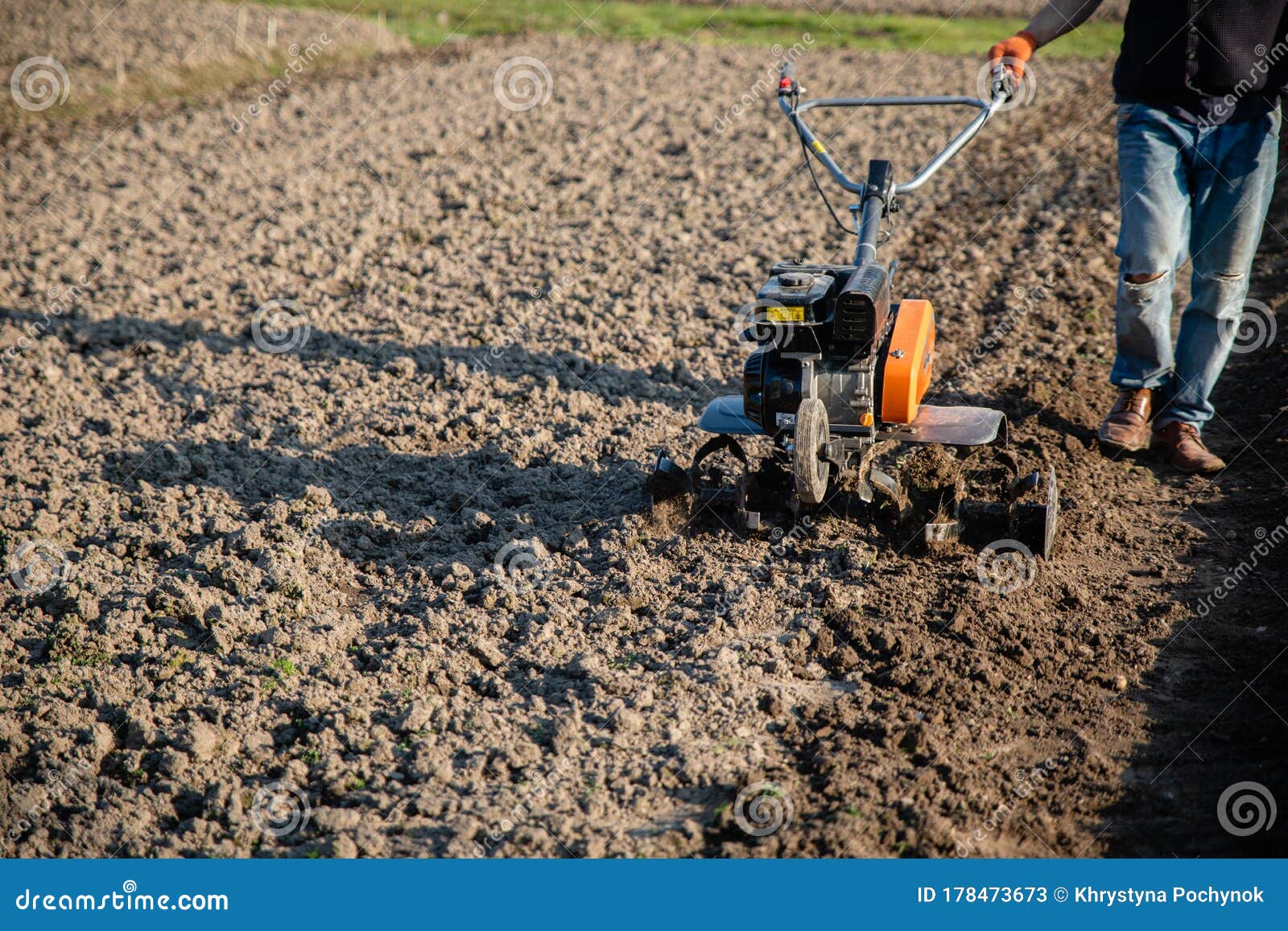 Small Plowing Machine in Hands of a Farmer Making Arable in Black Soil ...