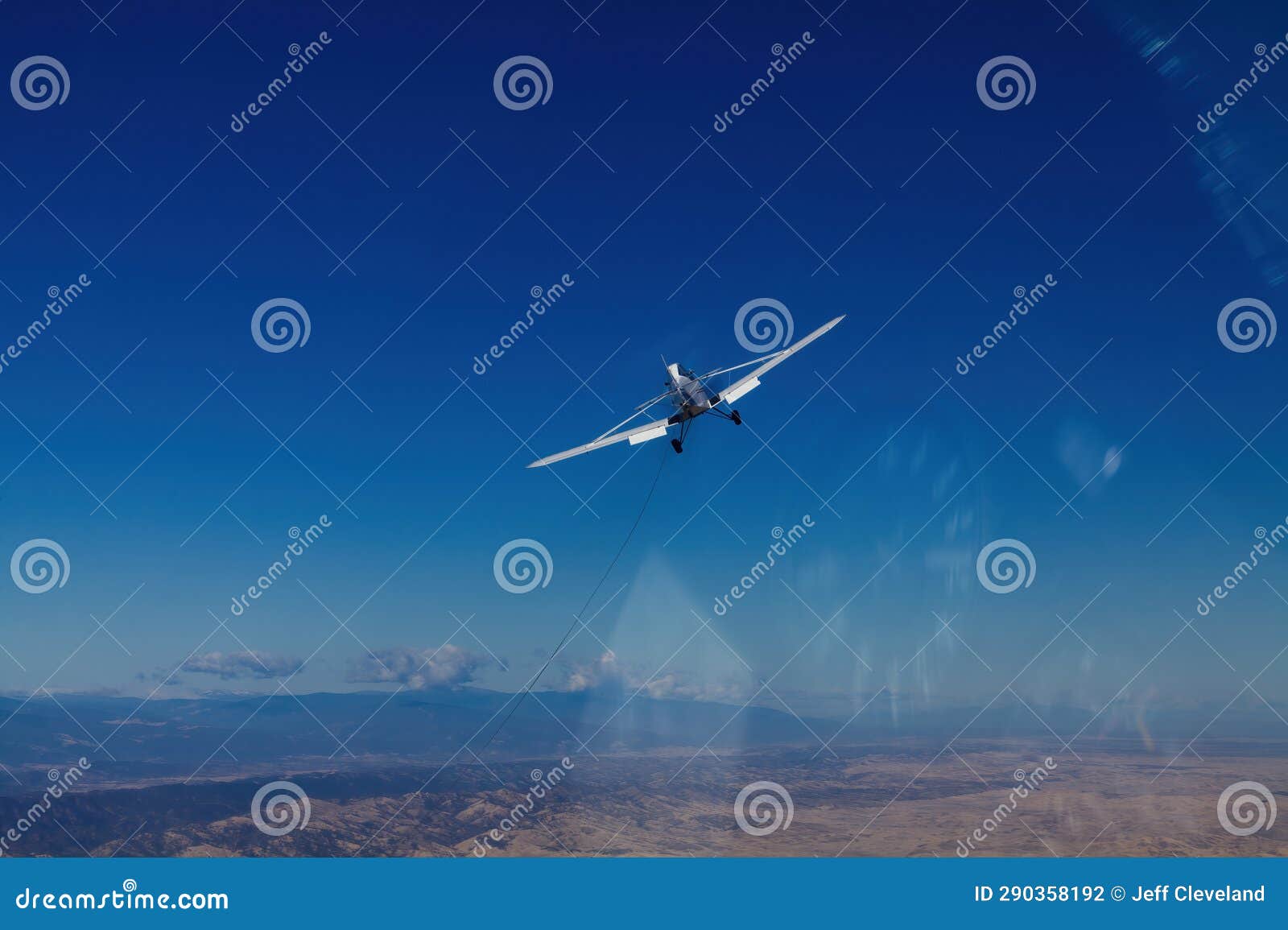 Small Propeller Plane with Tow Cable in Blue Sky Stock Photo - Image of ...
