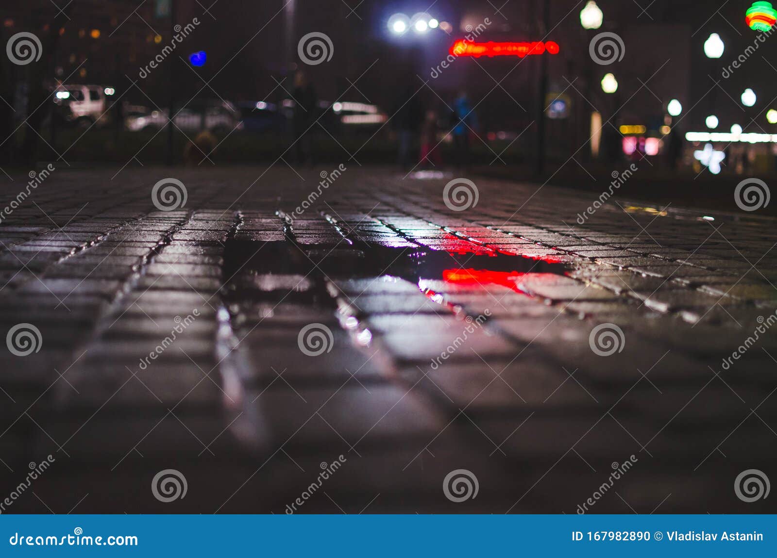 A Small Puddle on the Pavement. Night in the City Stock Photo - Image ...