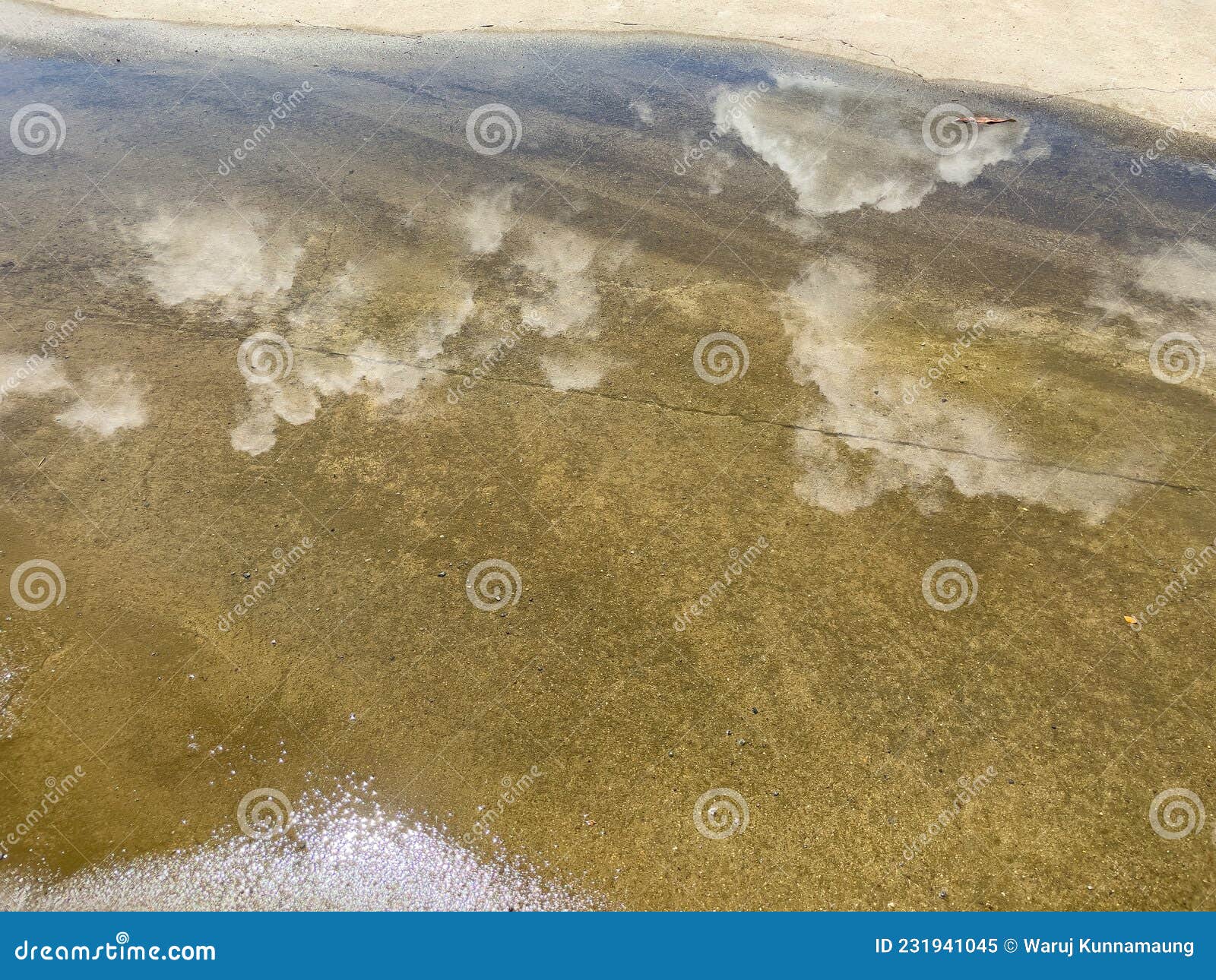 A Small Puddle of Water on the Cement Floor. Stock Image - Image of ...