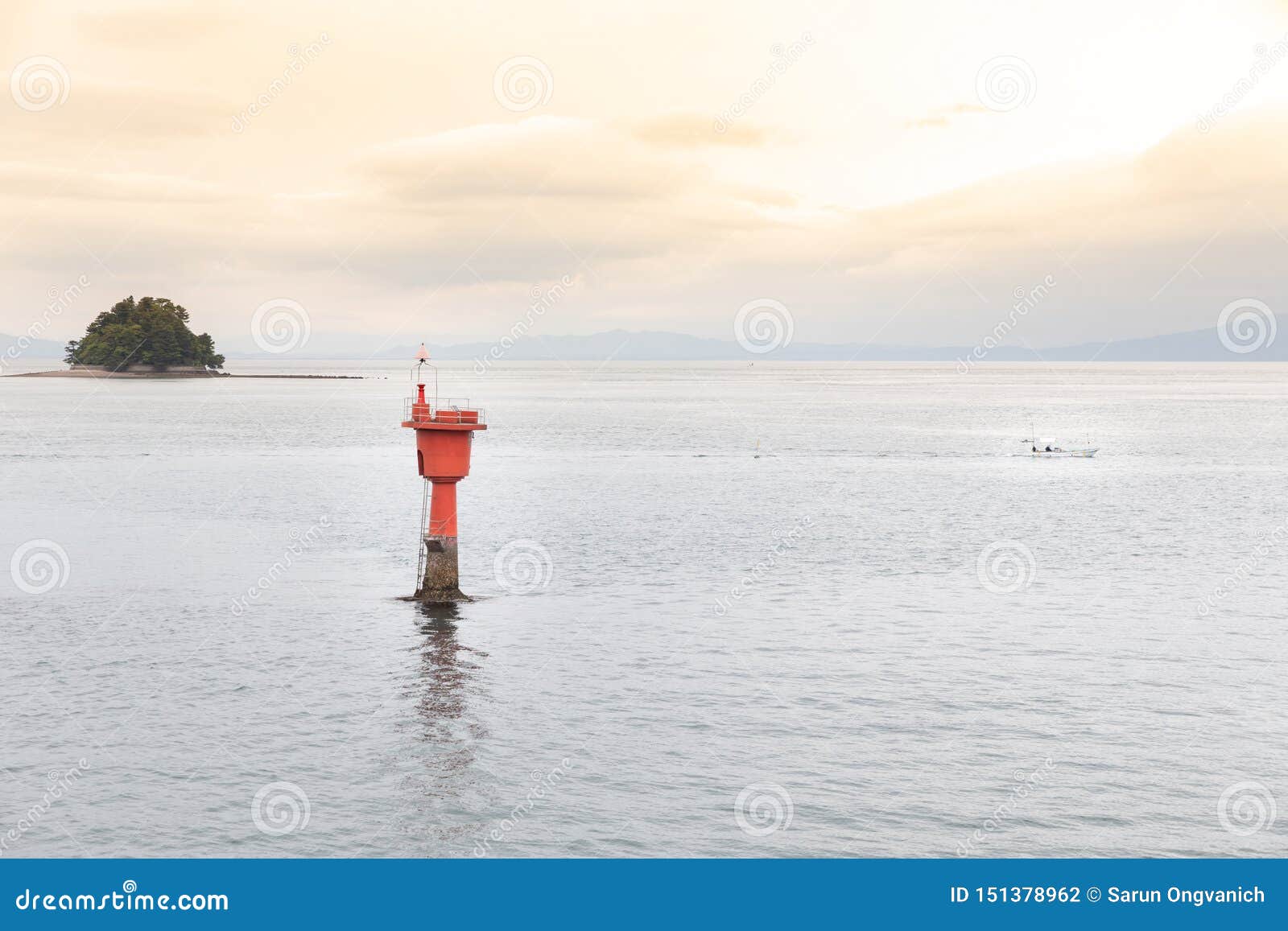 Small Red Lighthouse in the Middle of the Sea or Ocean Stock Photo ...
