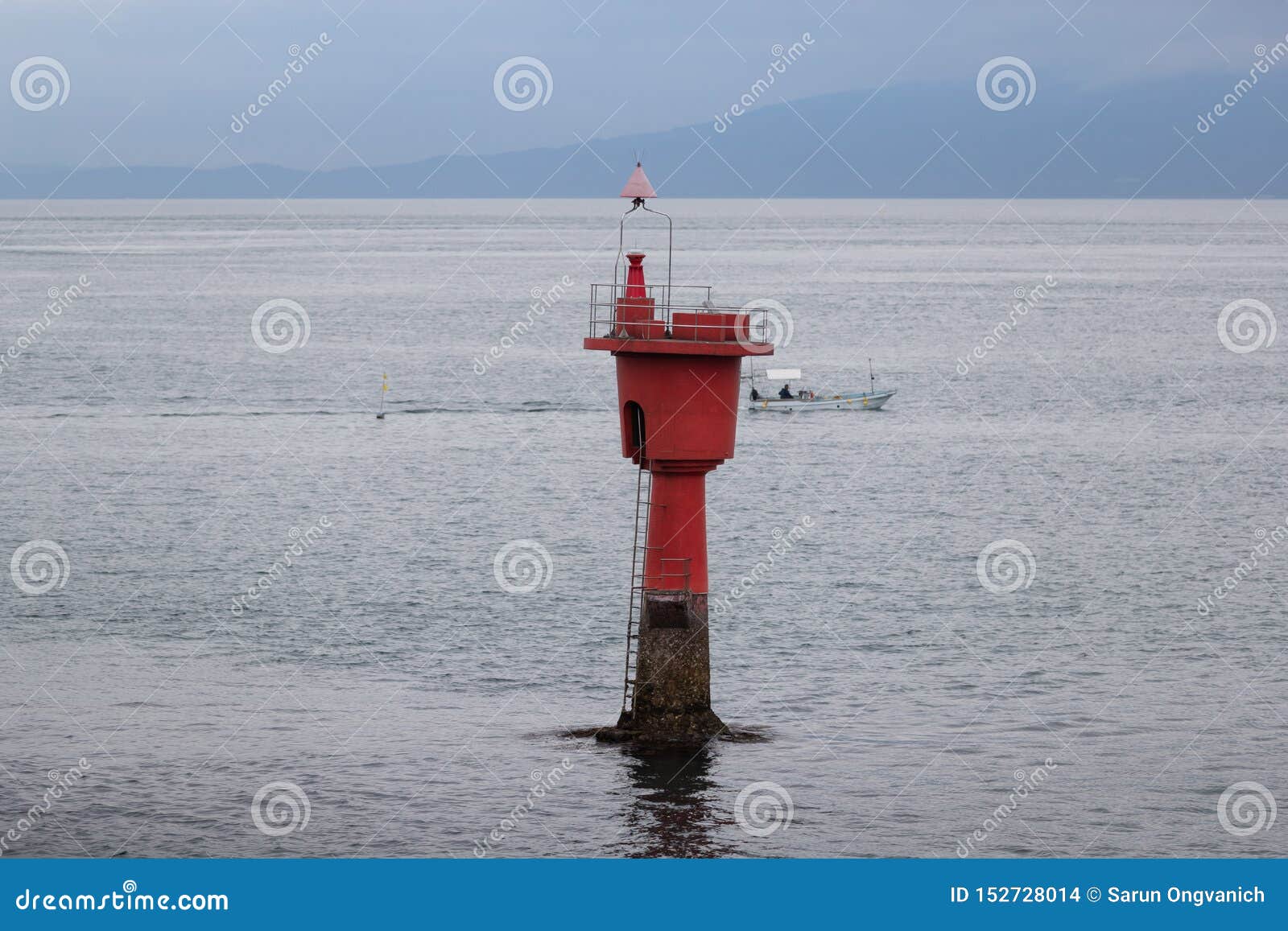 Small Red Lighthouse in the Middle of the Sea or Ocean Stock Photo ...