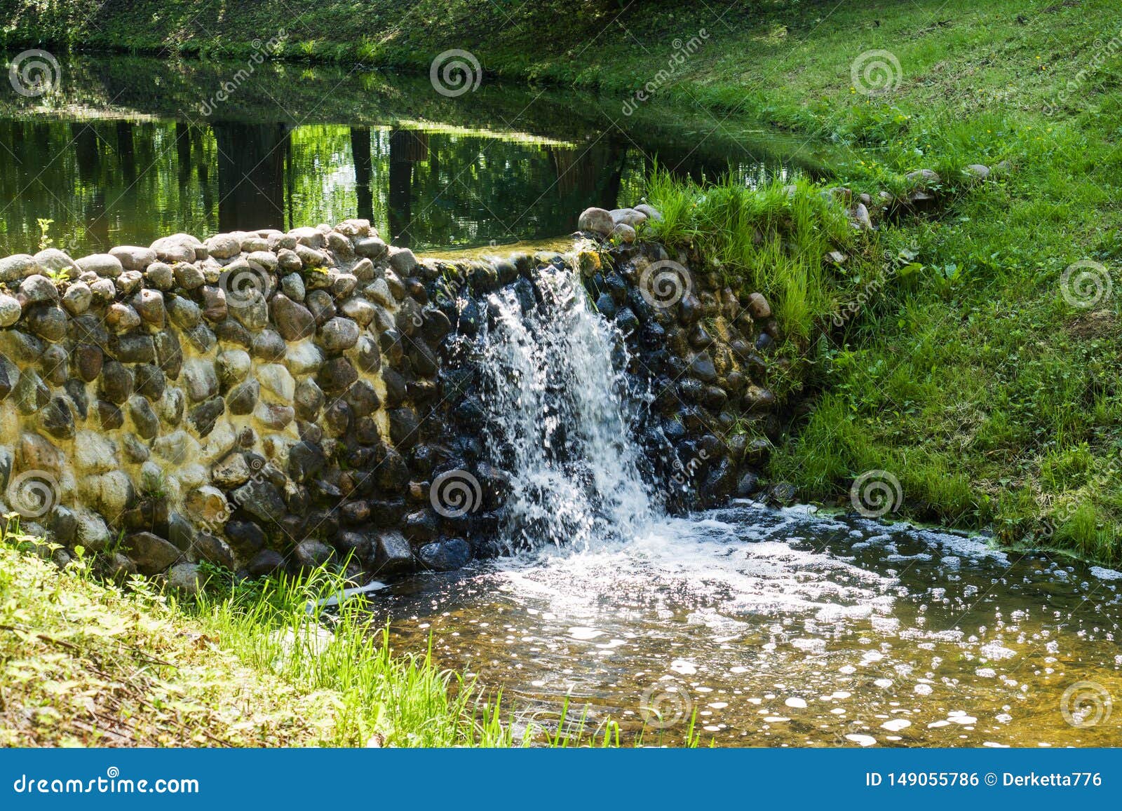 A Small River and an Artificial Waterfall in the Rocks Stock Photo ...