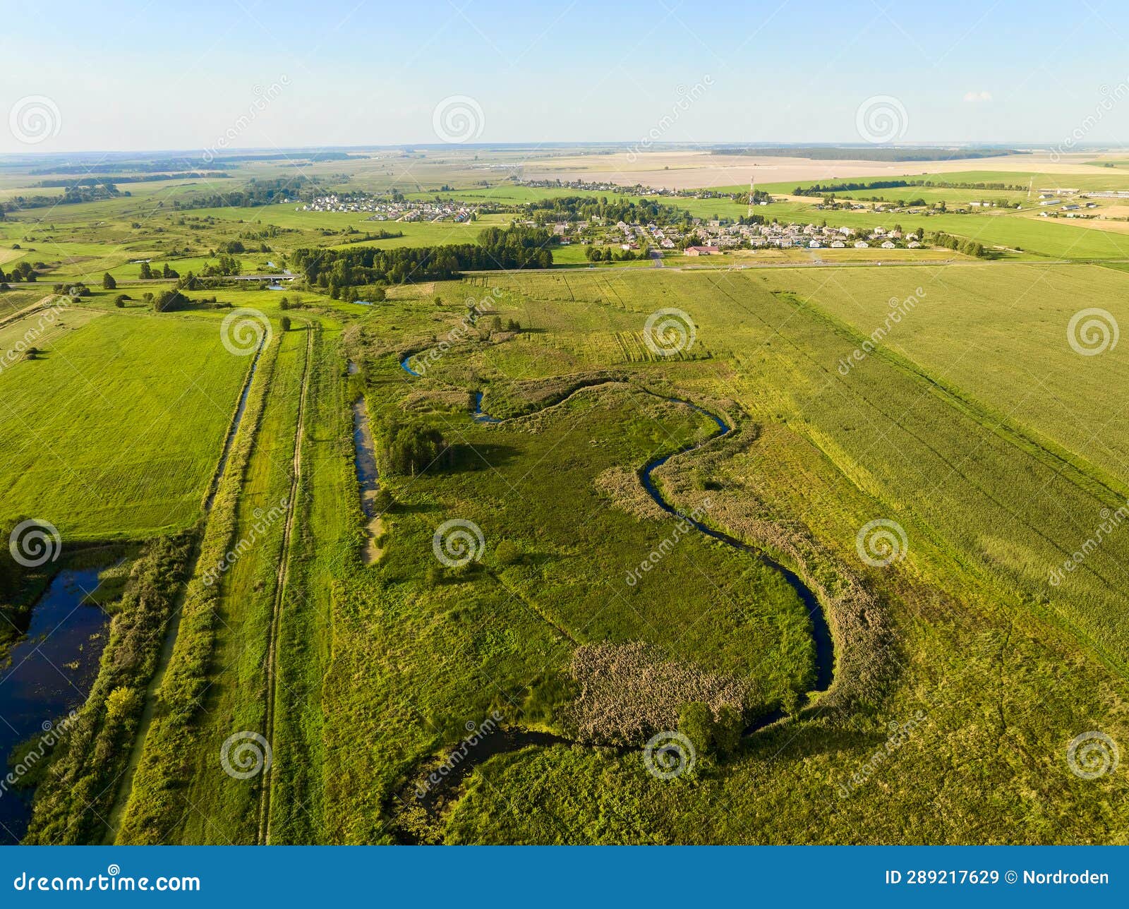 Small River Flows among Fields Illuminated by Sunset Light Stock Image ...