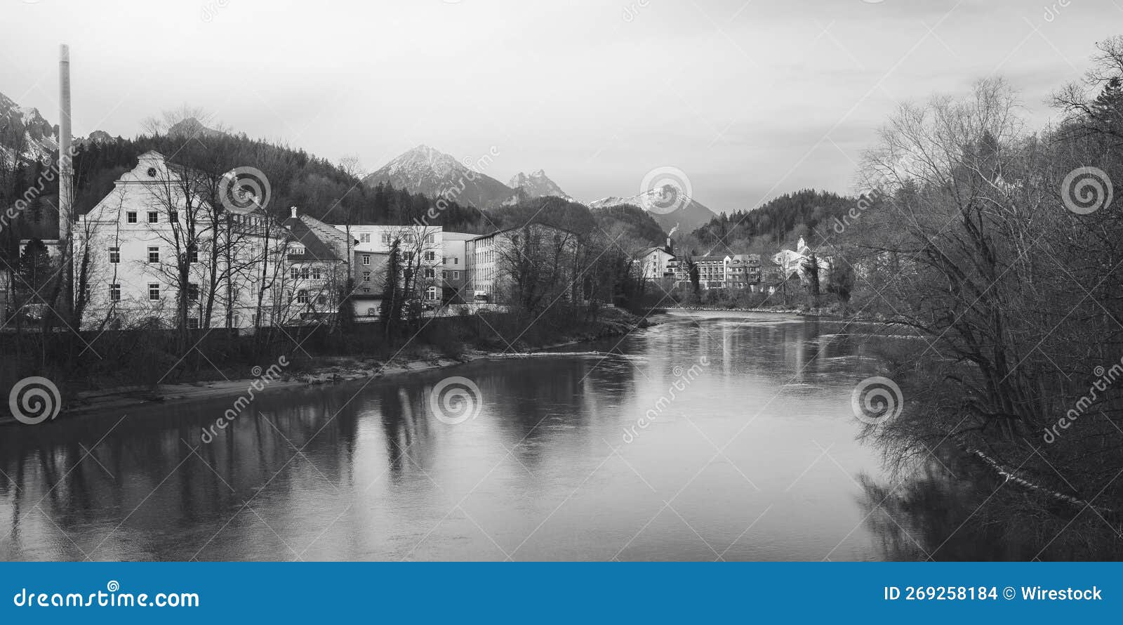 Small River in Front of a Town Next To a Mountain Stock Photo - Image ...