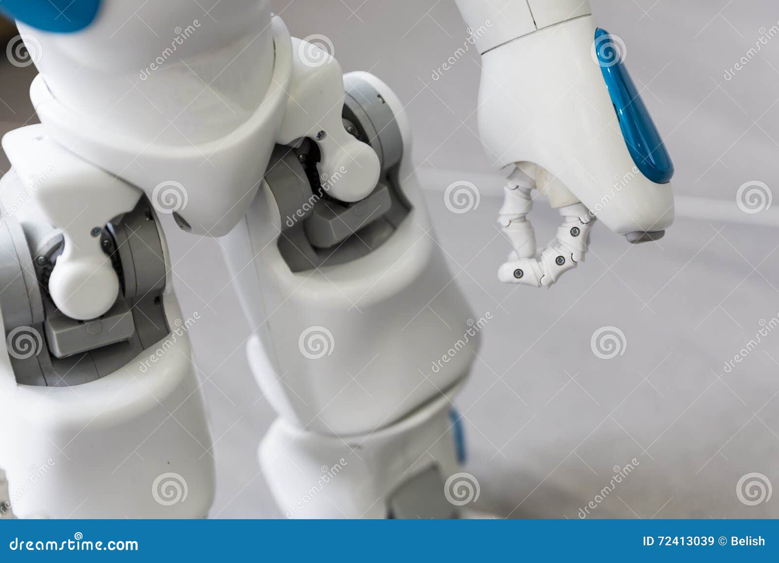 A Small Robot With A Human Face And A Humanoid Body. Artificial ...