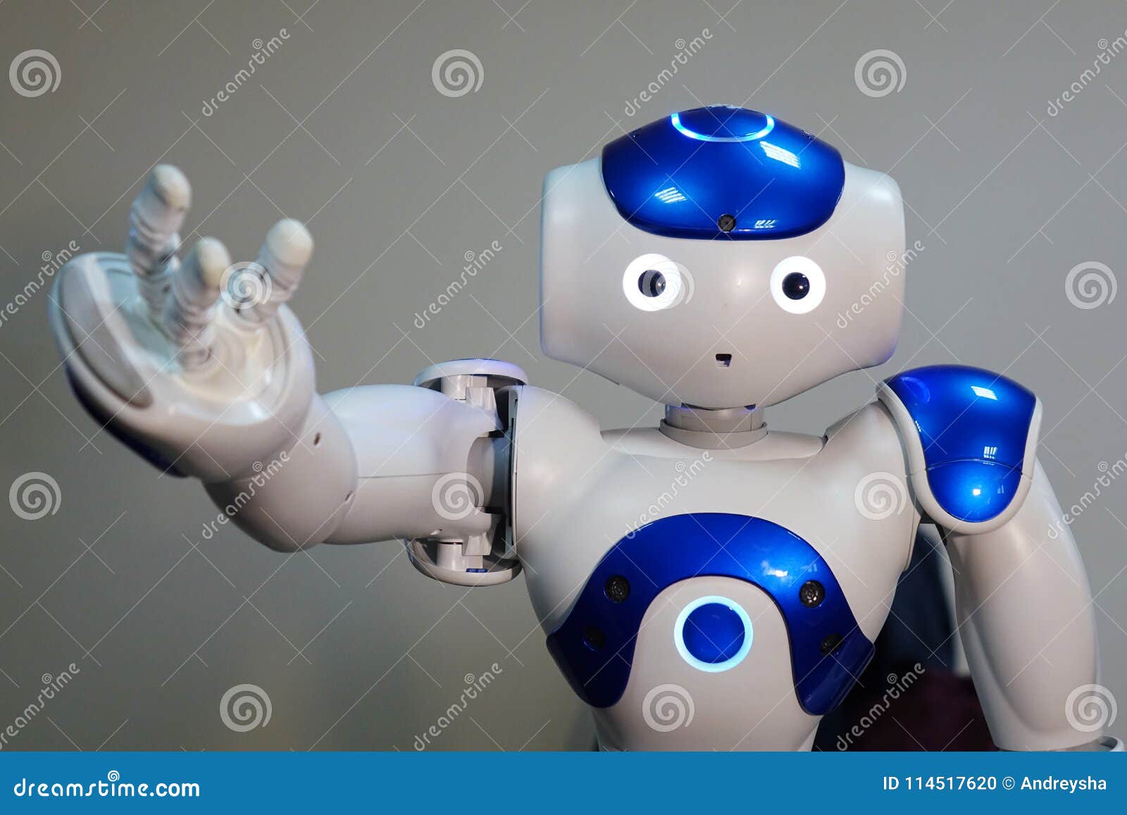 A Small Robot With A Humanoid Body On A Blue Background . Artificial ...
