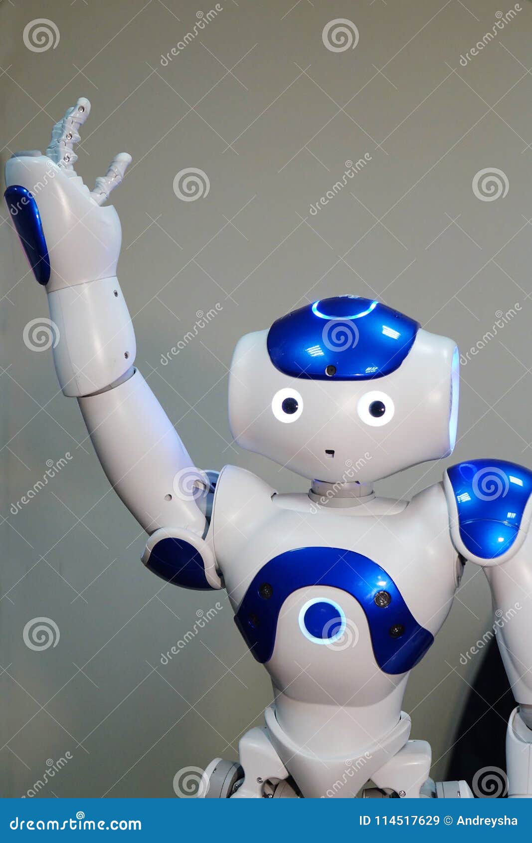 A Small Robot With A Humanoid Body On A Blue Background . Artificial ...
